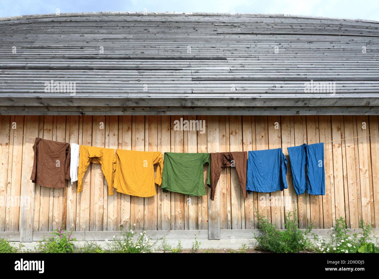 Laundry drying on line on wall background Stock Photo - Alamy