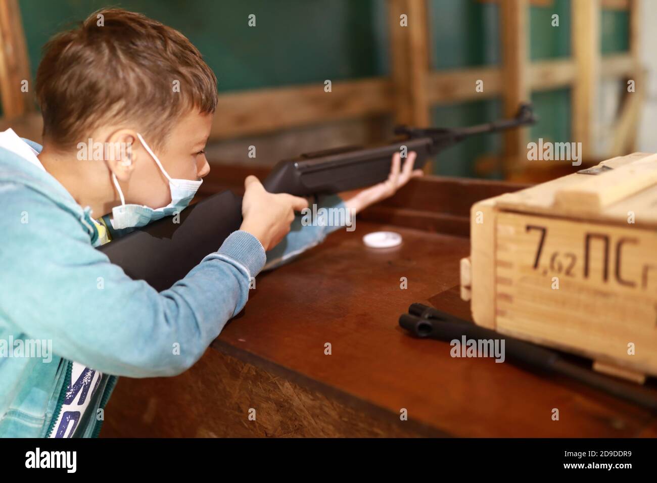 Boy shoots air rifle at shooting range Stock Photo - Alamy