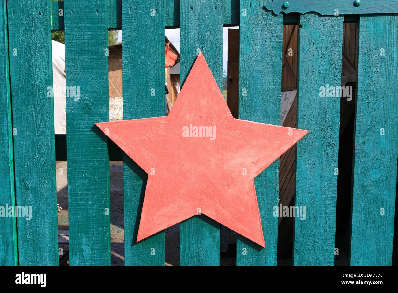 View of green wooden gate with red star Stock Photo - Alamy