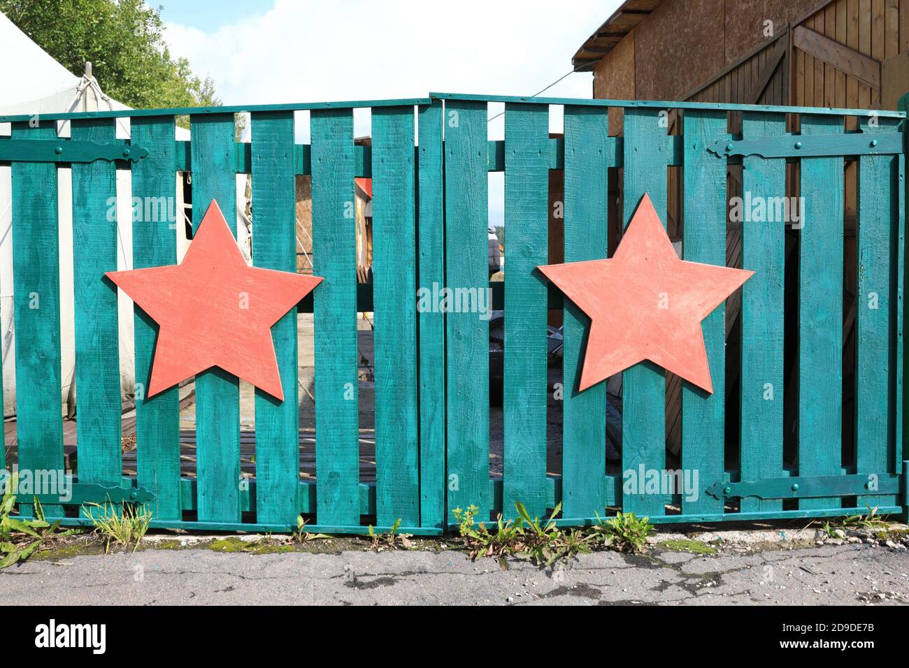 View of wooden gate with red stars Stock Photo - Alamy