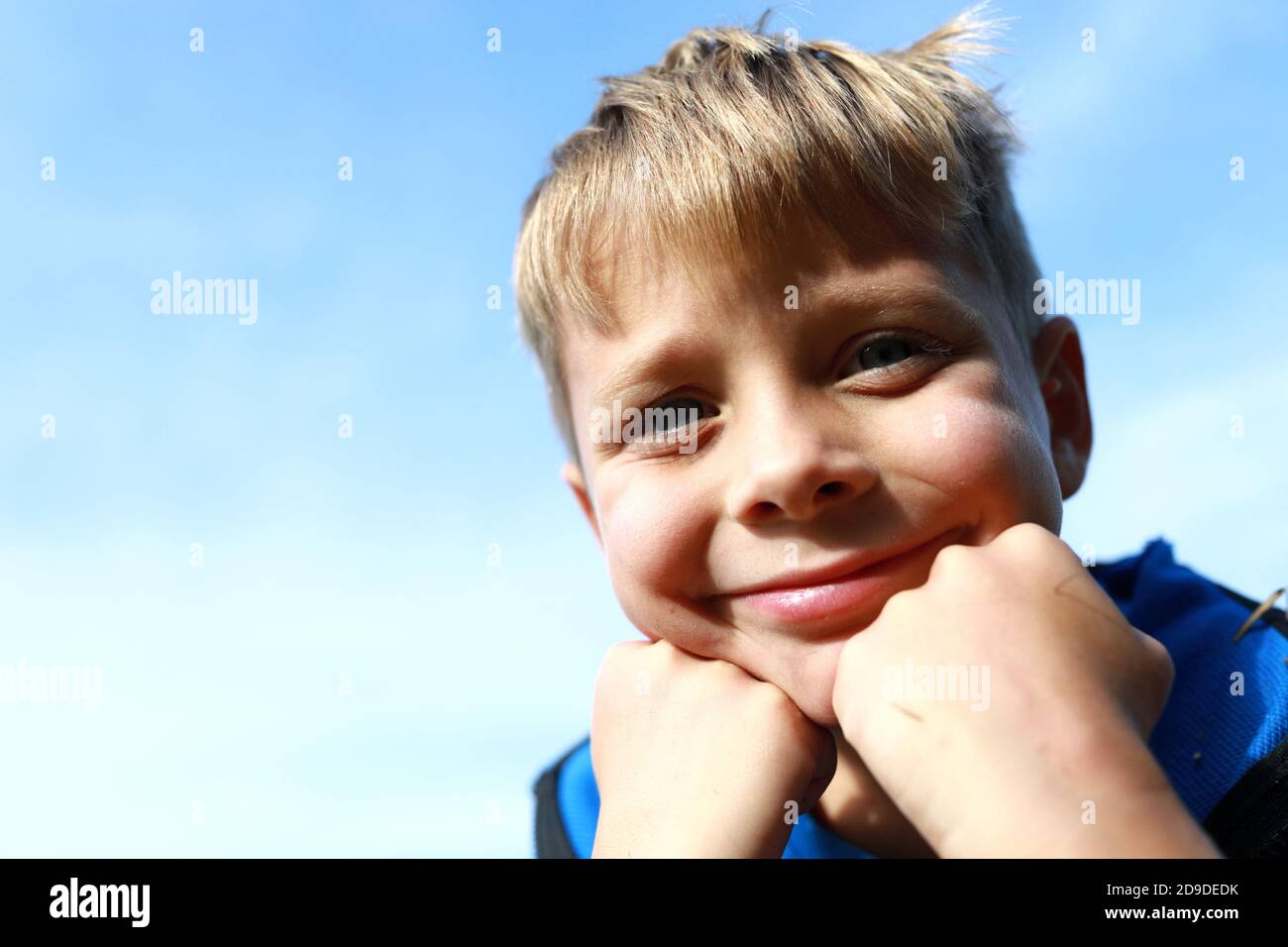 Portrait of smiling boy on sky background Stock Photo - Alamy