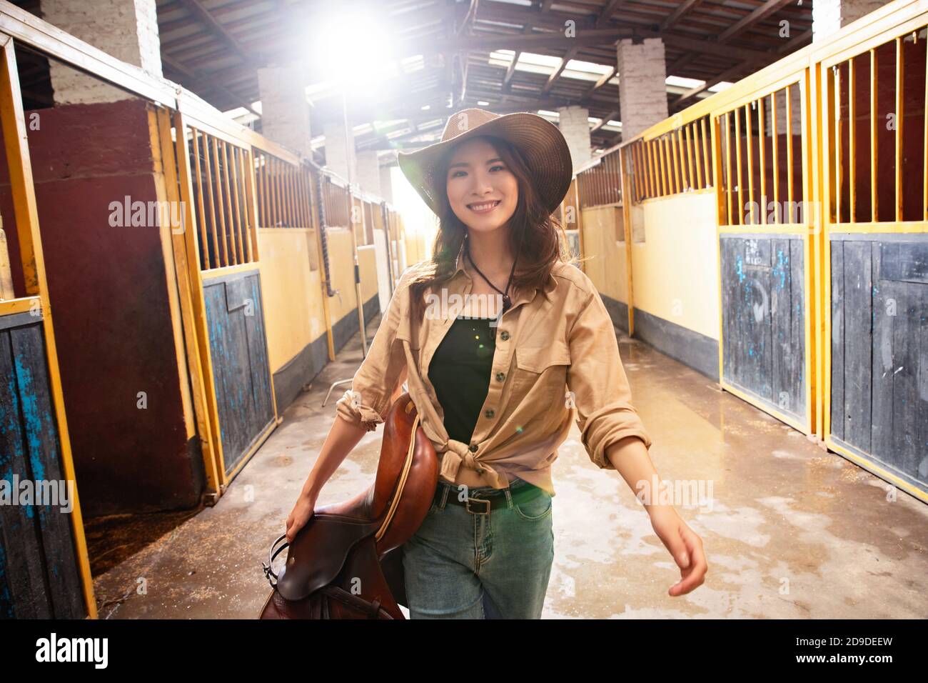 The stable with the saddle of young women walk Stock Photo - Alamy