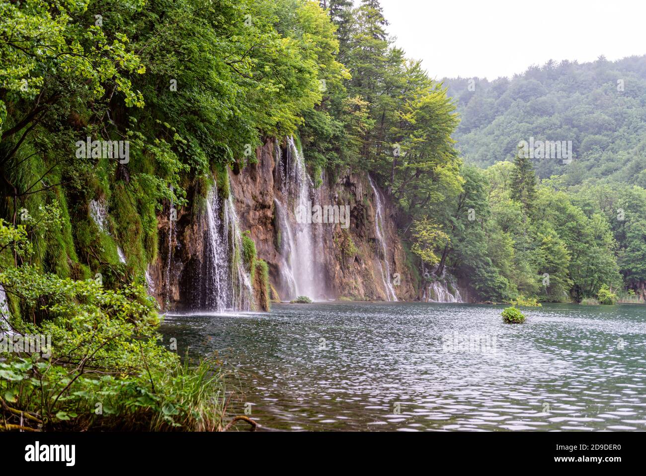 Beautiful waterfall and blue limpid lake in Plitvice Lakes National ...
