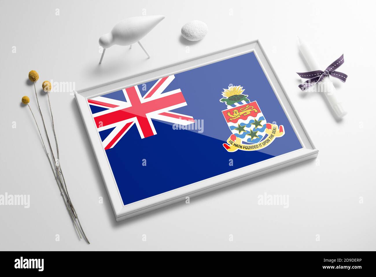 Cayman Islands flag in wooden frame on table. White natural soft ...