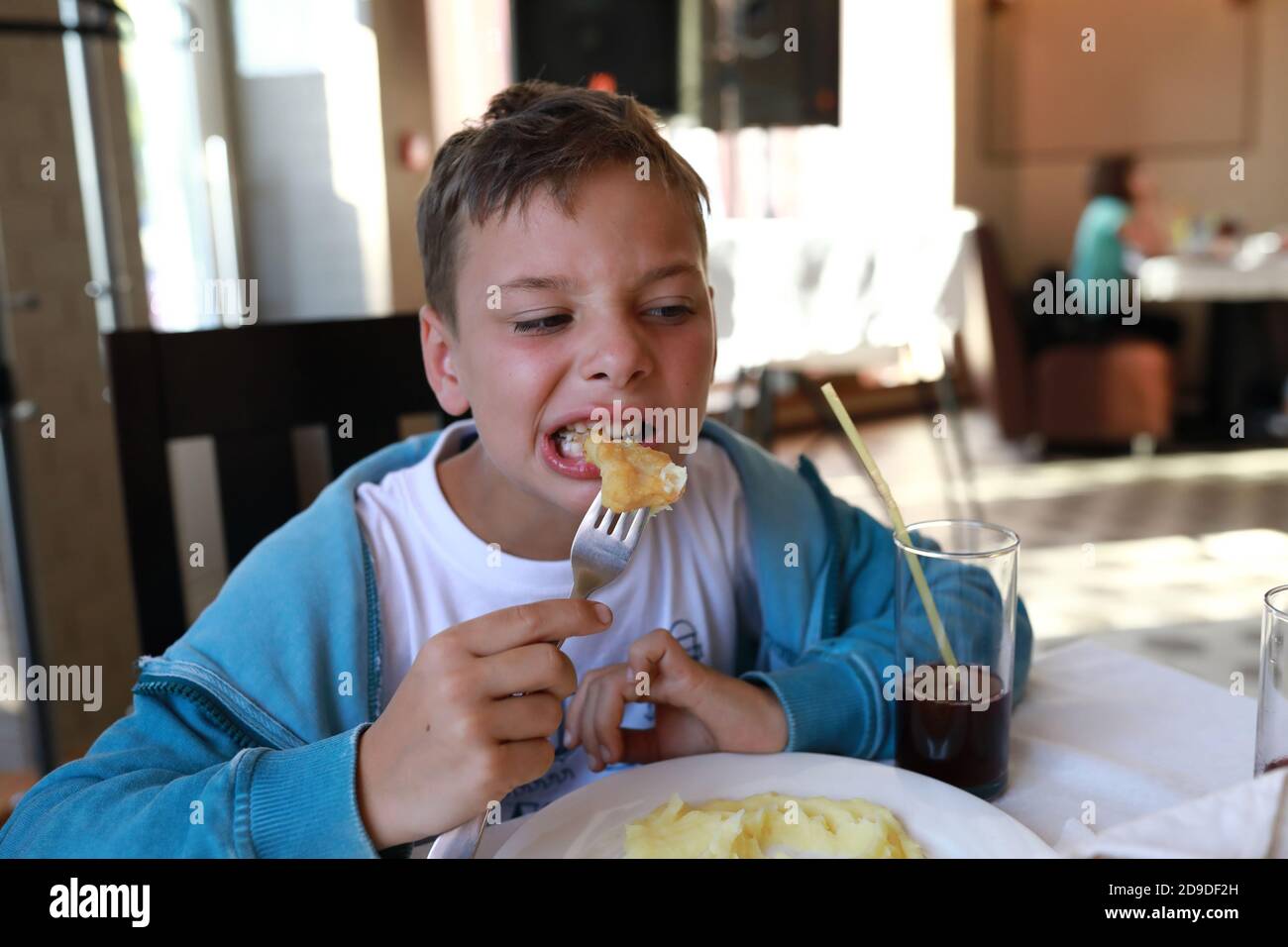 Boy eating nuggets with mashed potatoes in restaurant Stock Photo - Alamy