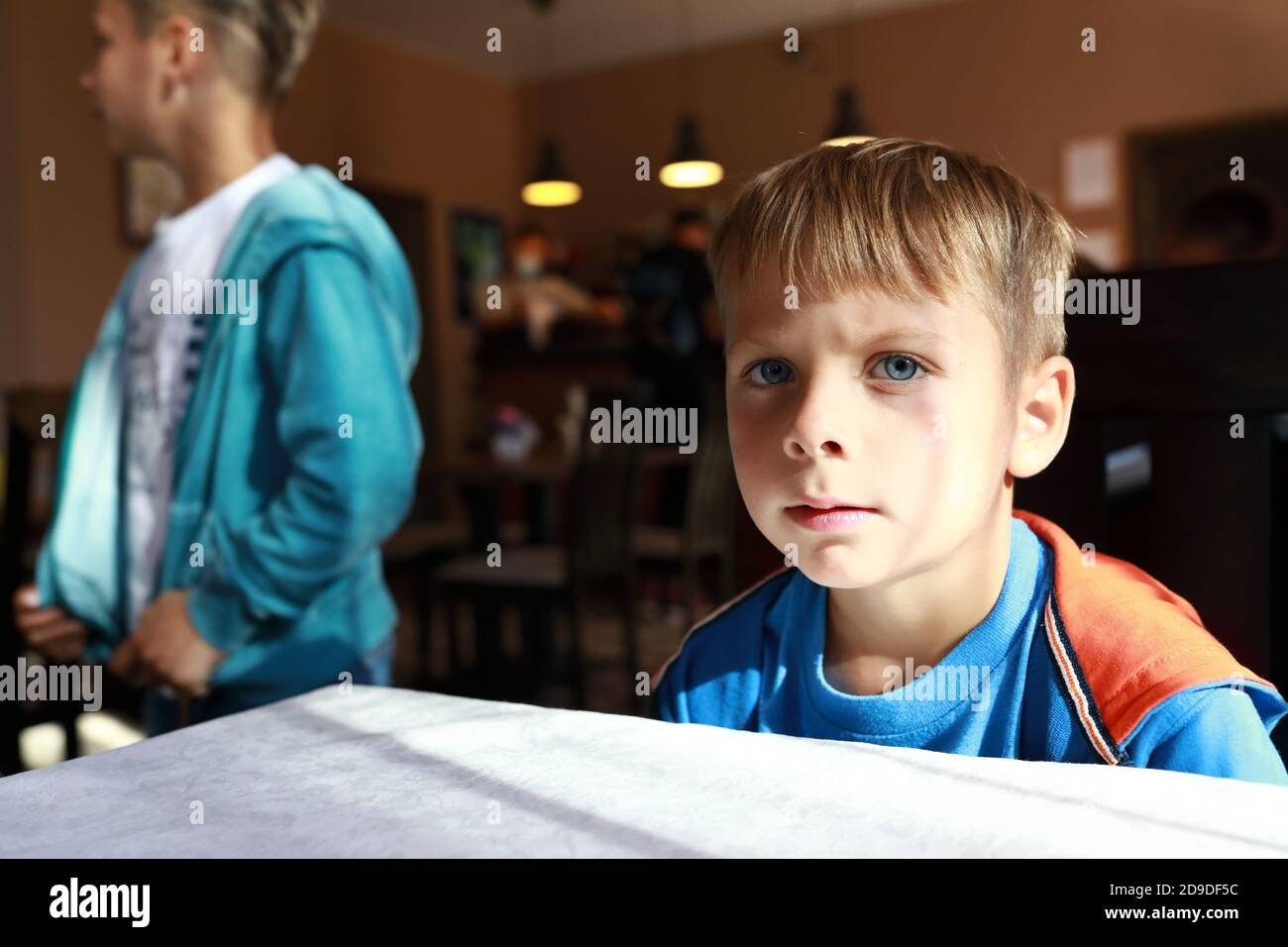 Portrait of serious kid in a restaurant Stock Photo - Alamy