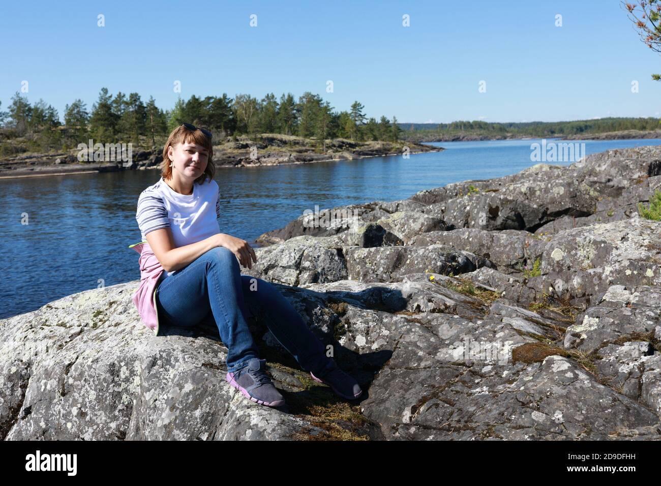 Woman on island in lake Ladoga skerries, Karelia Stock Photo - Alamy