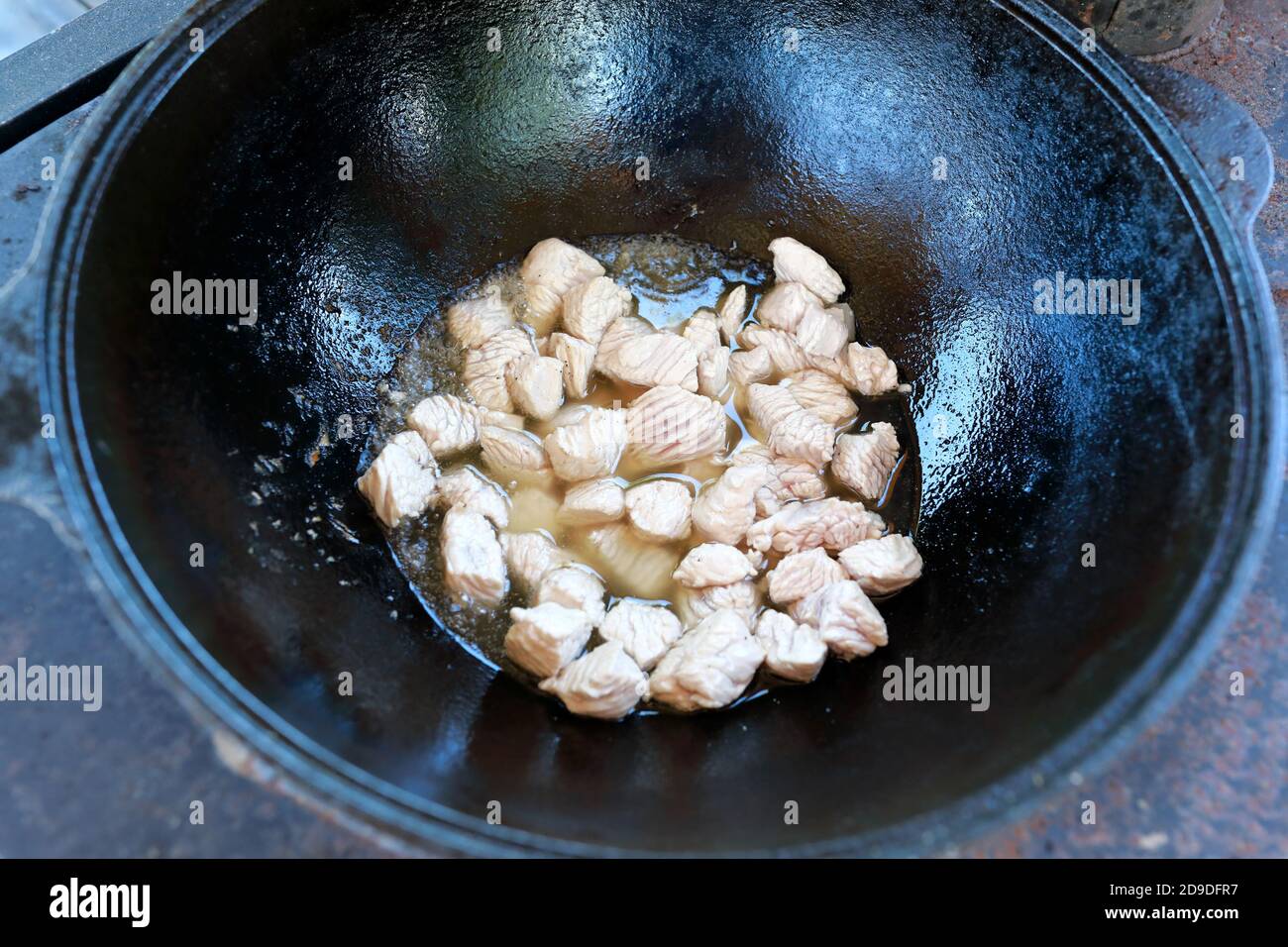 Cooking meat in a cauldron for pilaf Stock Photo - Alamy