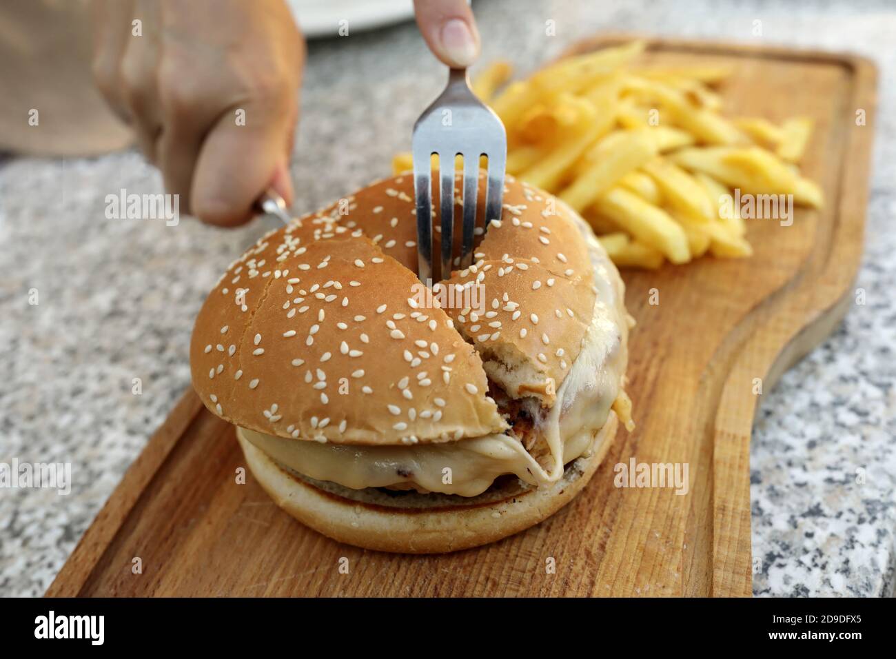 Knife cuts half delicious hamburger hi-res stock photography and images ...