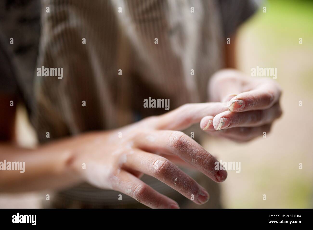 Close up young girl hands cleaning clay from fingers Stock Photo - Alamy