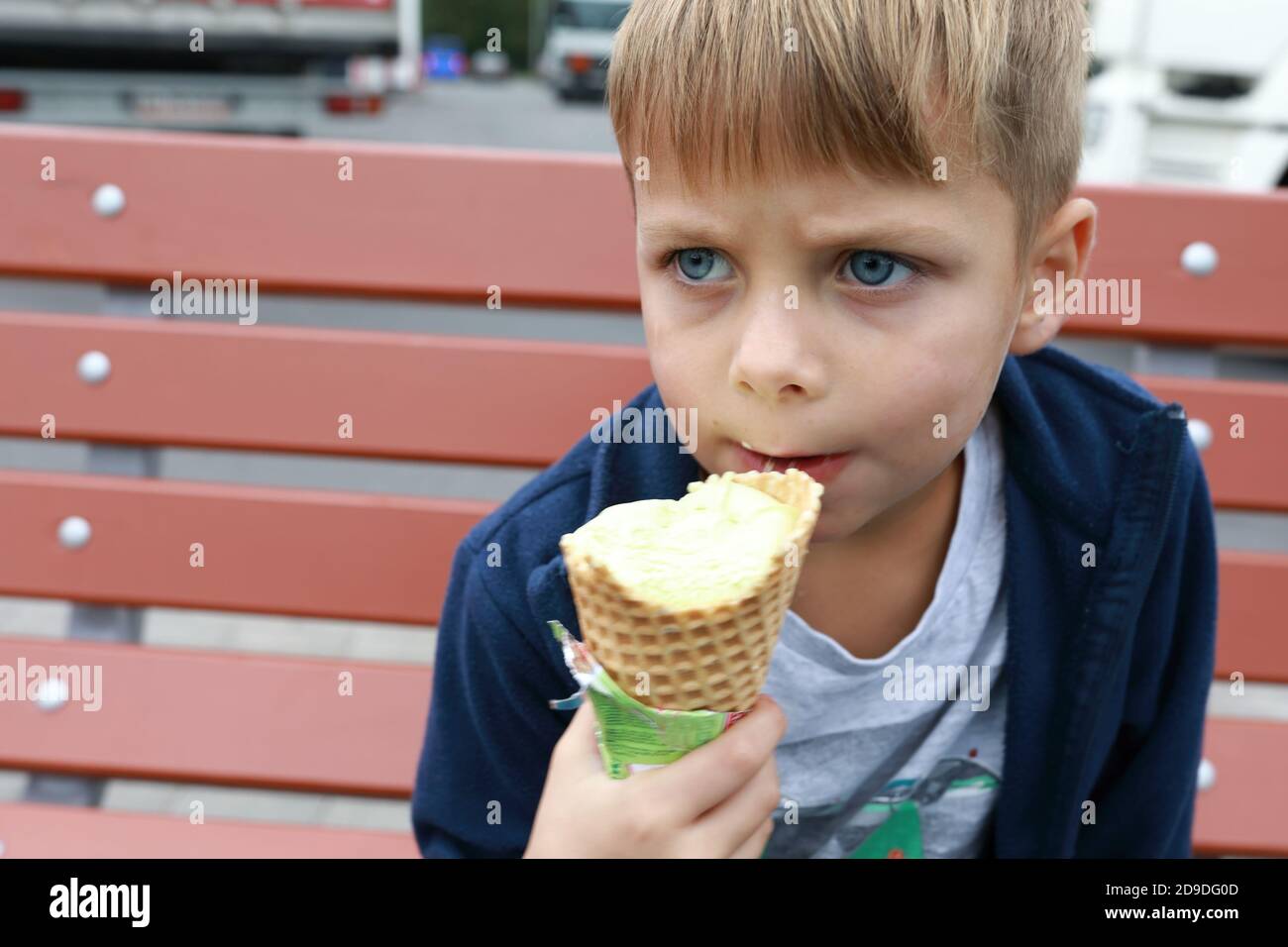 Child has ice cream on wooden bench Stock Photo - Alamy