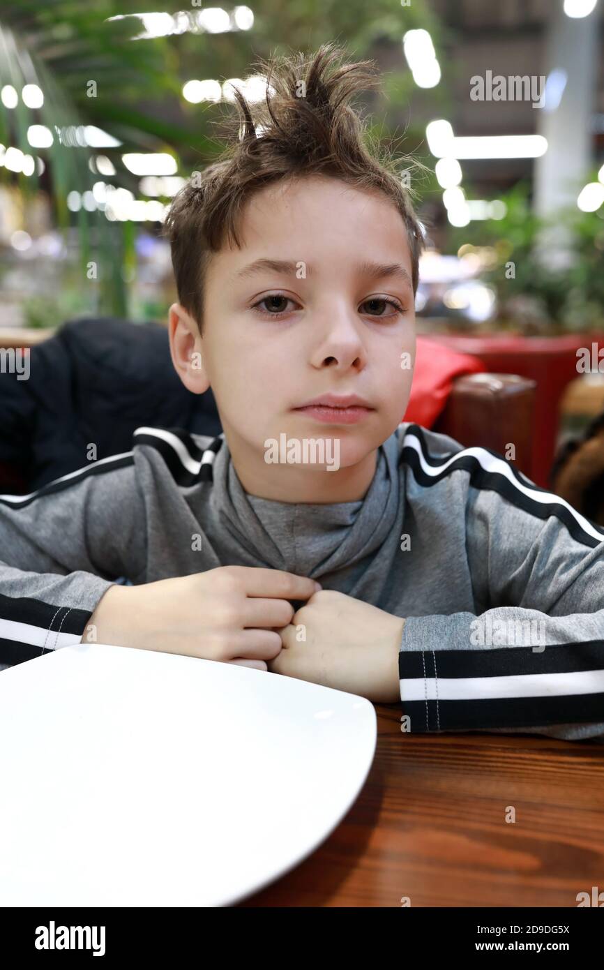 Portrait of pensive boy in a restaurant Stock Photo - Alamy