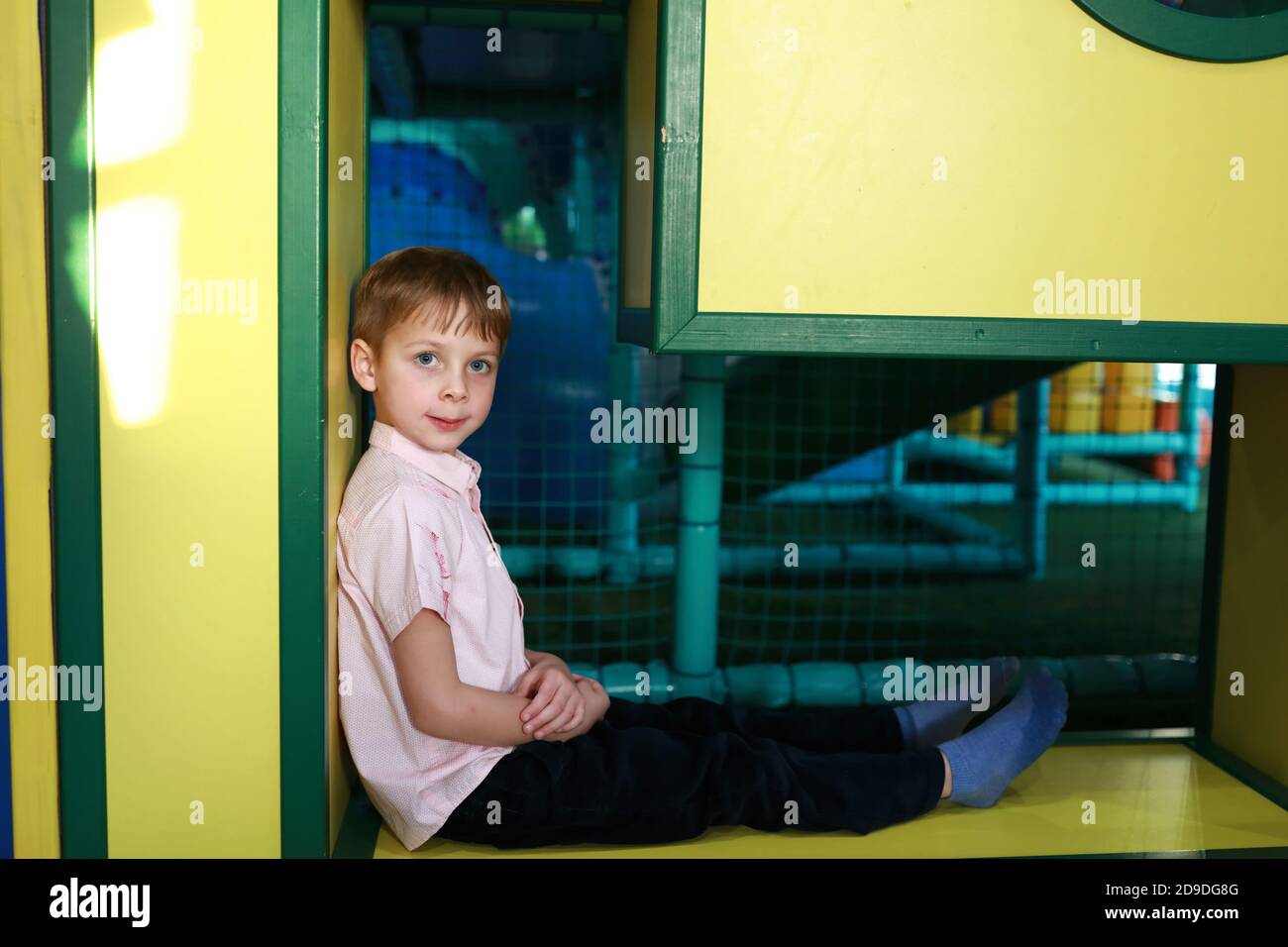 Portrait of child posing in indoor playground Stock Photo - Alamy