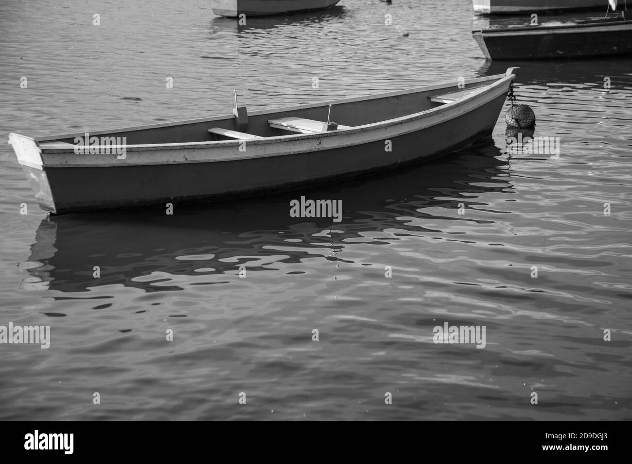 Grayscale shot of a boat in the sea with a reflection Stock Photo - Alamy