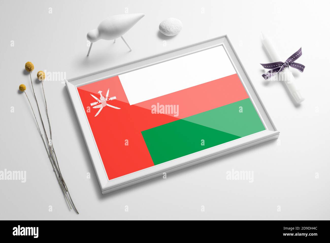 Oman flag in wooden frame on table. White natural soft concept ...