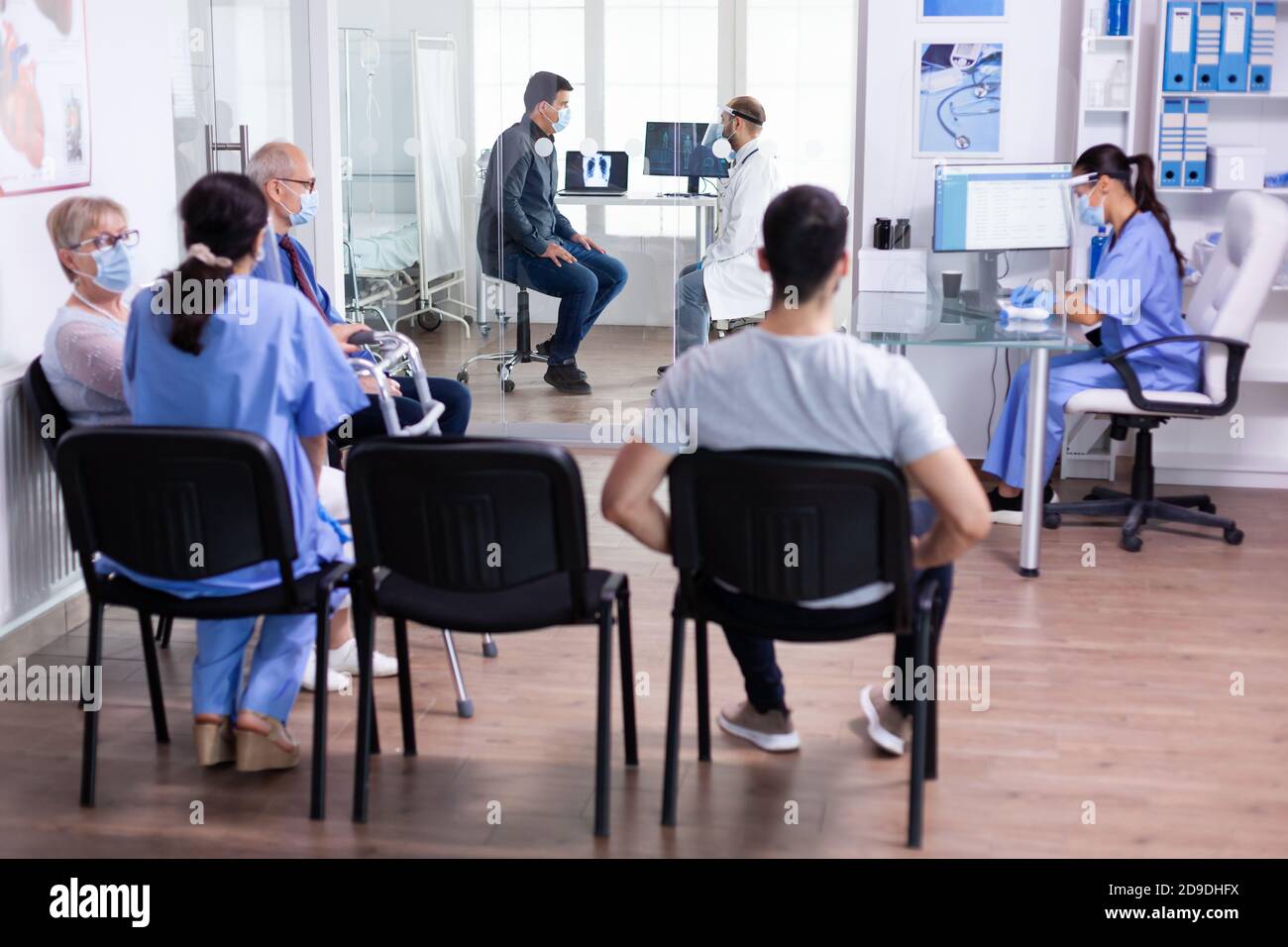 Doctor wearing visor as safety precaution during examination in ...