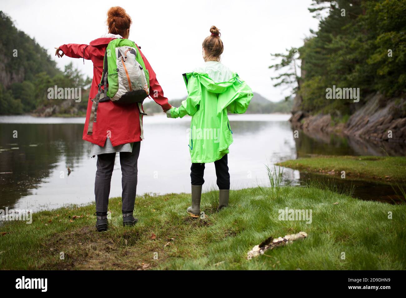 Full length portrait from behind two people standing by lakeside Stock ...