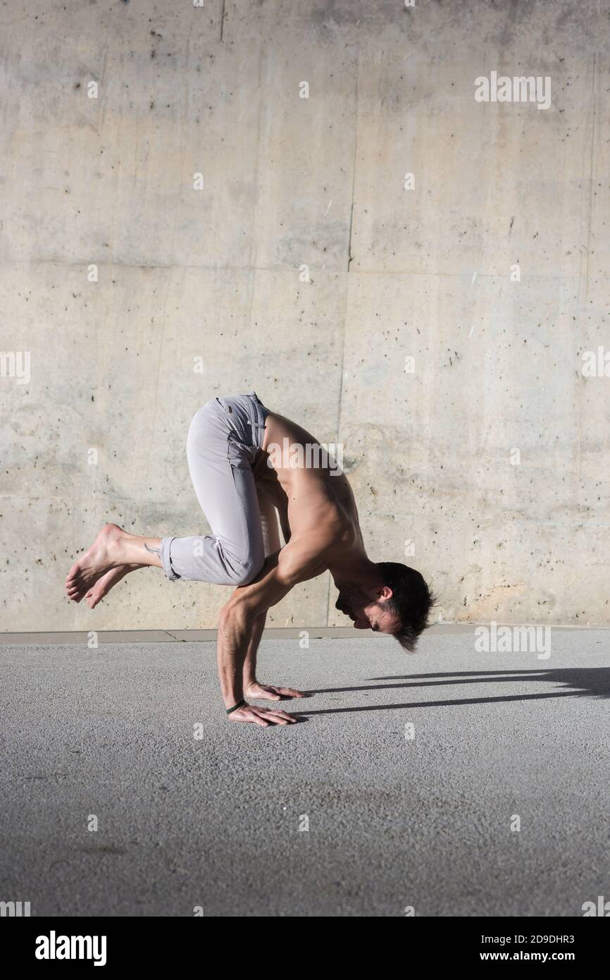 Man performing advanced yoga exercises and stretching to keep the body ...