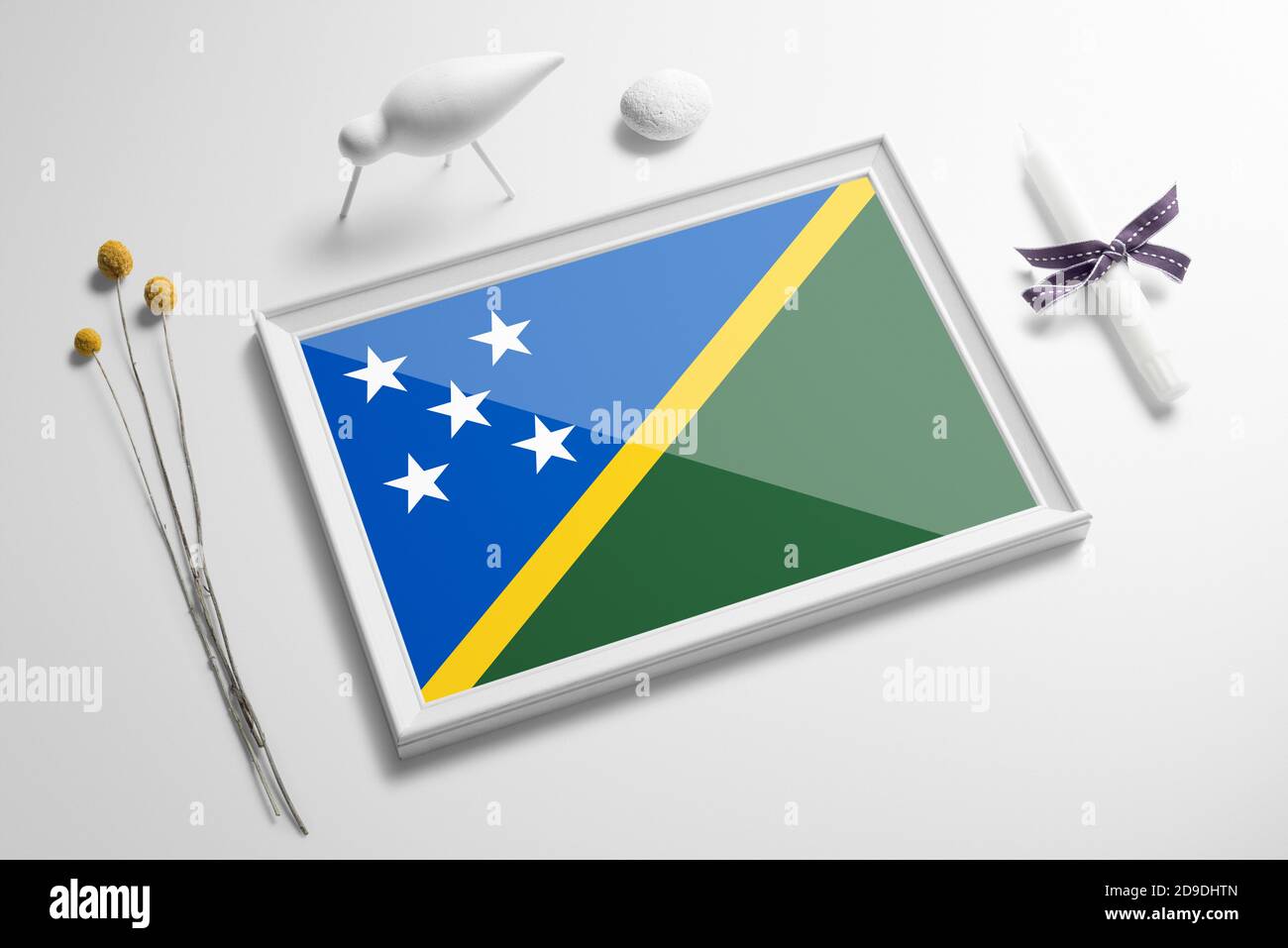 Solomon Islands flag in wooden frame on table. White natural soft ...