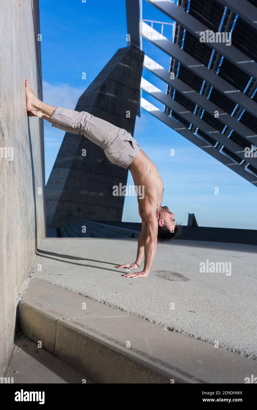Man performing advanced yoga exercises and stretching to keep the body ...