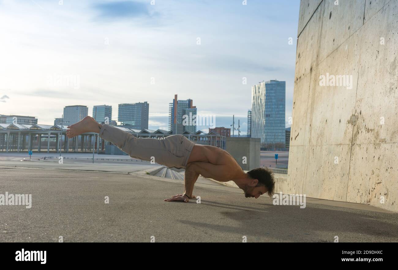 Man performing advanced yoga exercises and stretching to keep the body ...