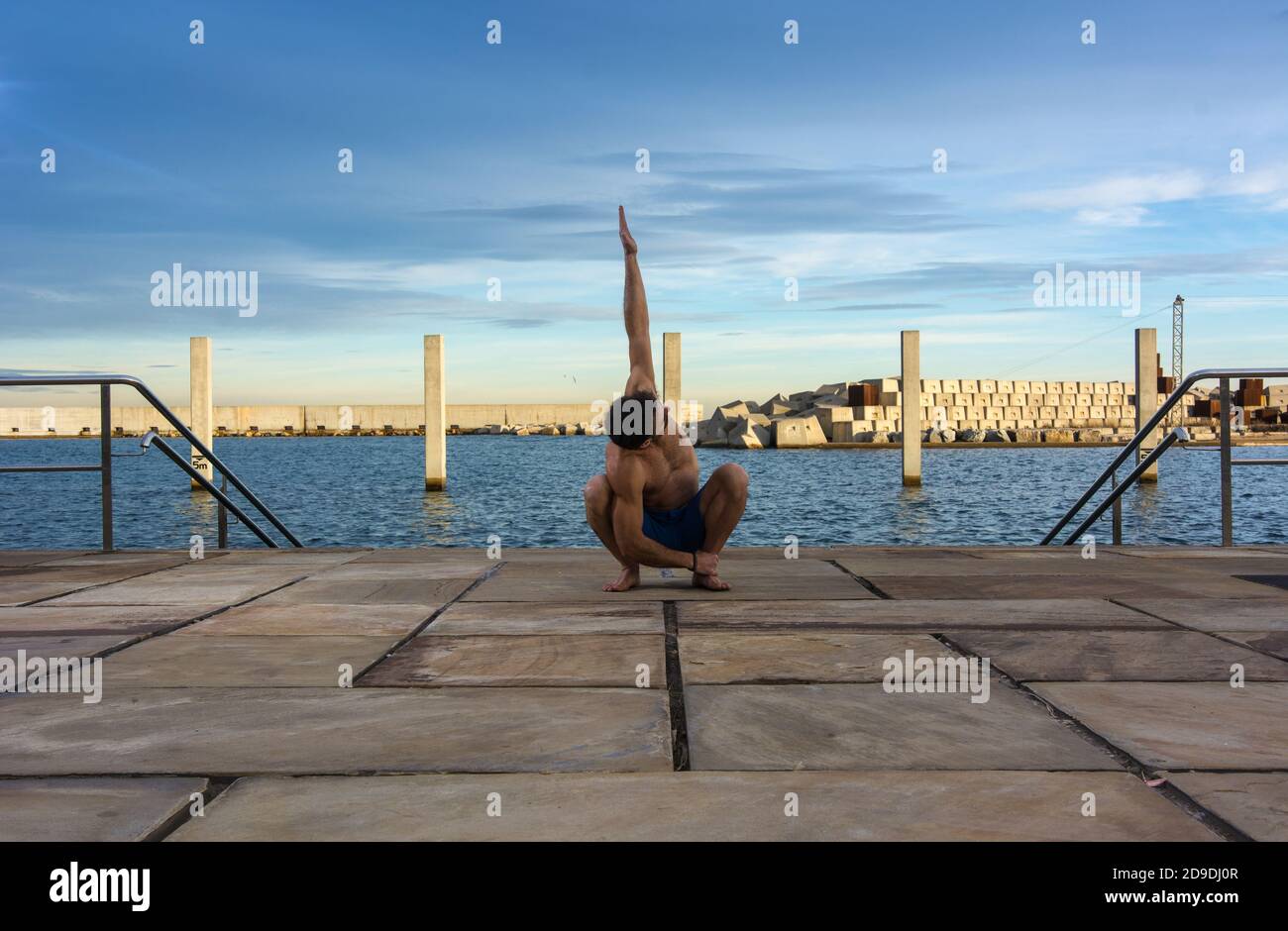 Man performing advanced yoga exercises and stretching to keep the body ...