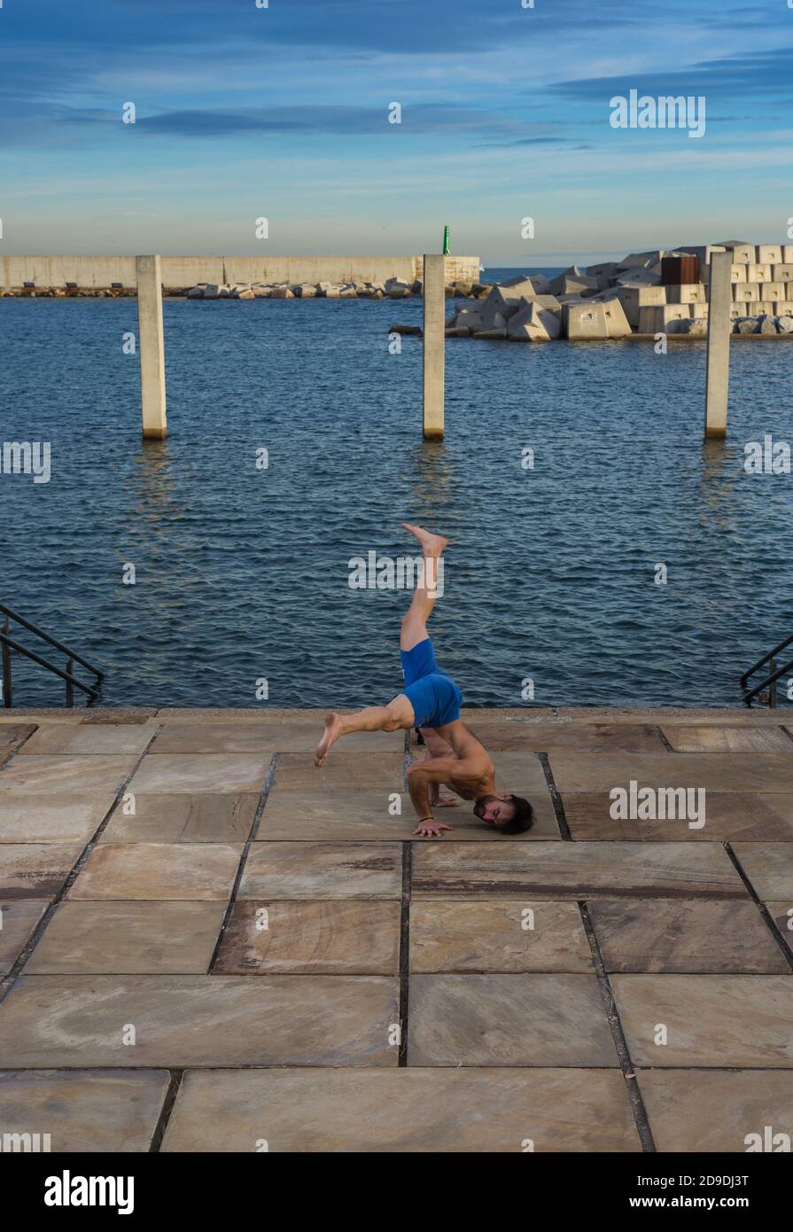 Man performing advanced yoga exercises and stretching to keep the body ...