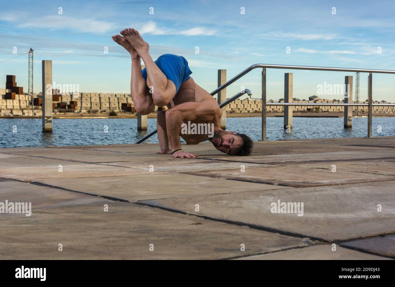 Man performing advanced yoga exercises and stretching to keep the body ...