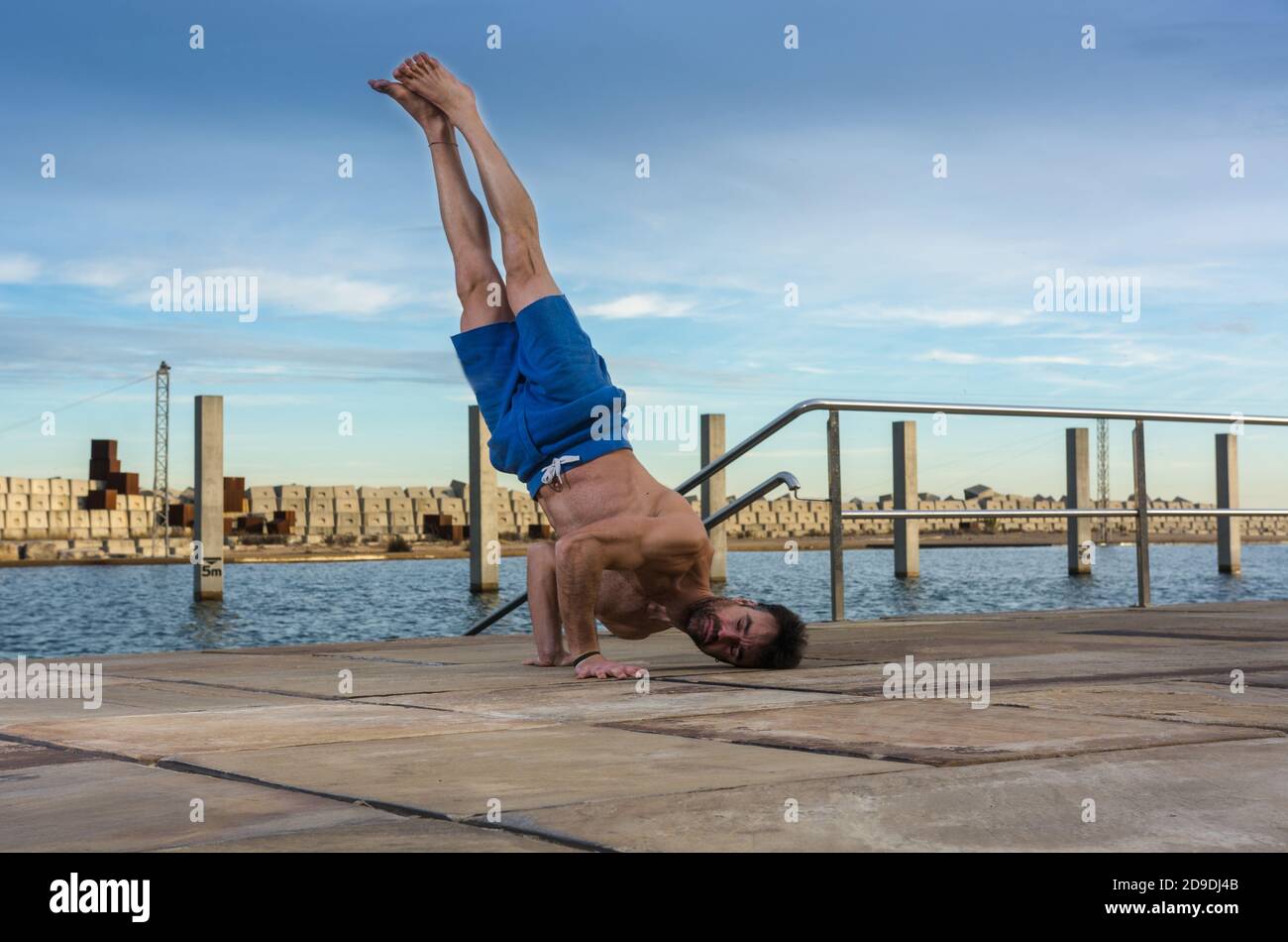 Man performing advanced yoga exercises and stretching to keep the body ...