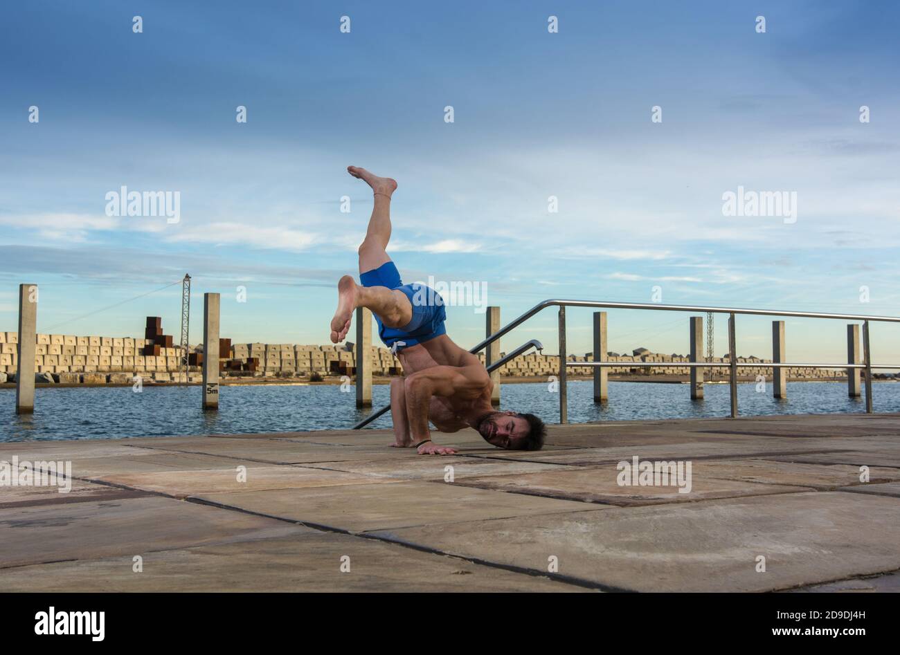 Man performing advanced yoga exercises and stretching to keep the body ...