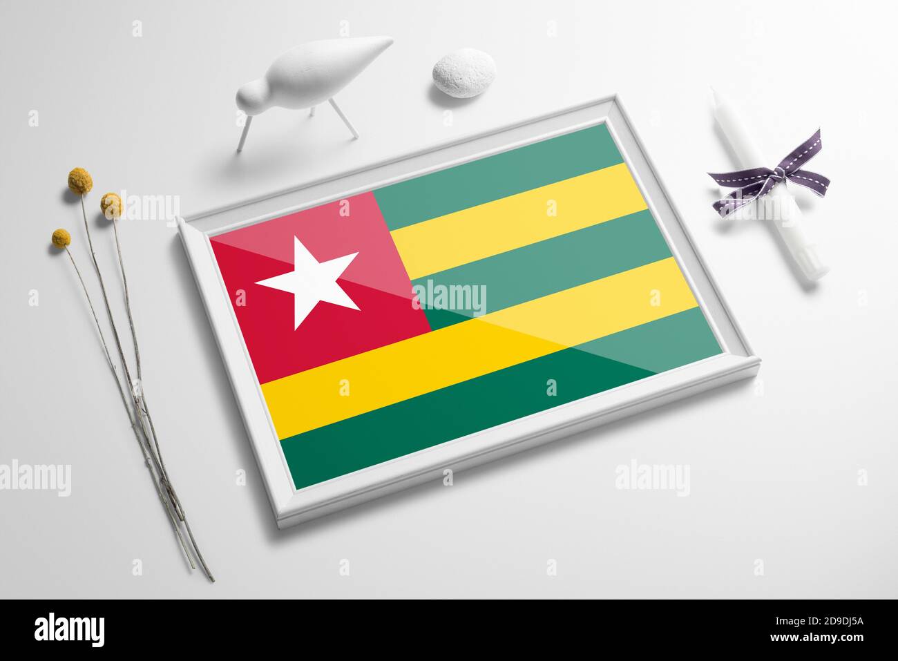 Togo flag in wooden frame on table. White natural soft concept ...