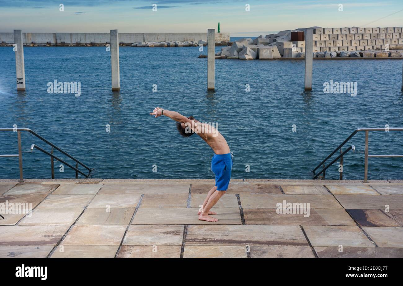 Man performing advanced yoga exercises and stretching to keep the body ...