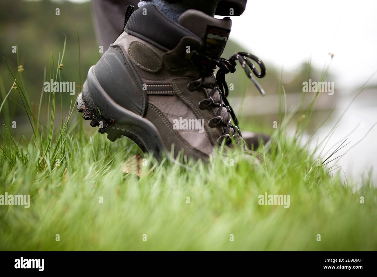 Close up side portrait hiker walking in boots on grass Stock Photo - Alamy