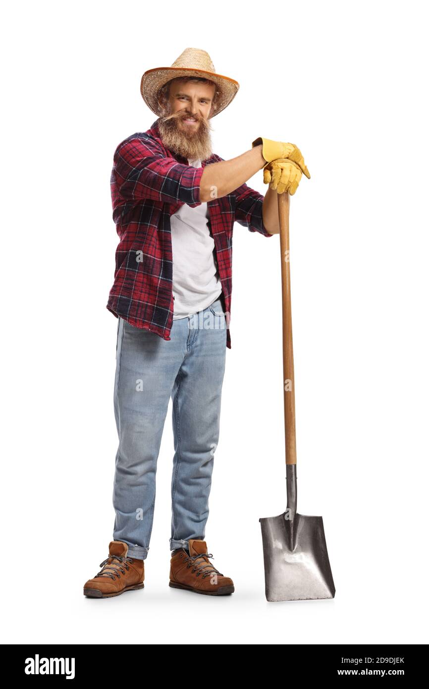 Full length portrait of a bearded farmer with standing and leaning on a ...