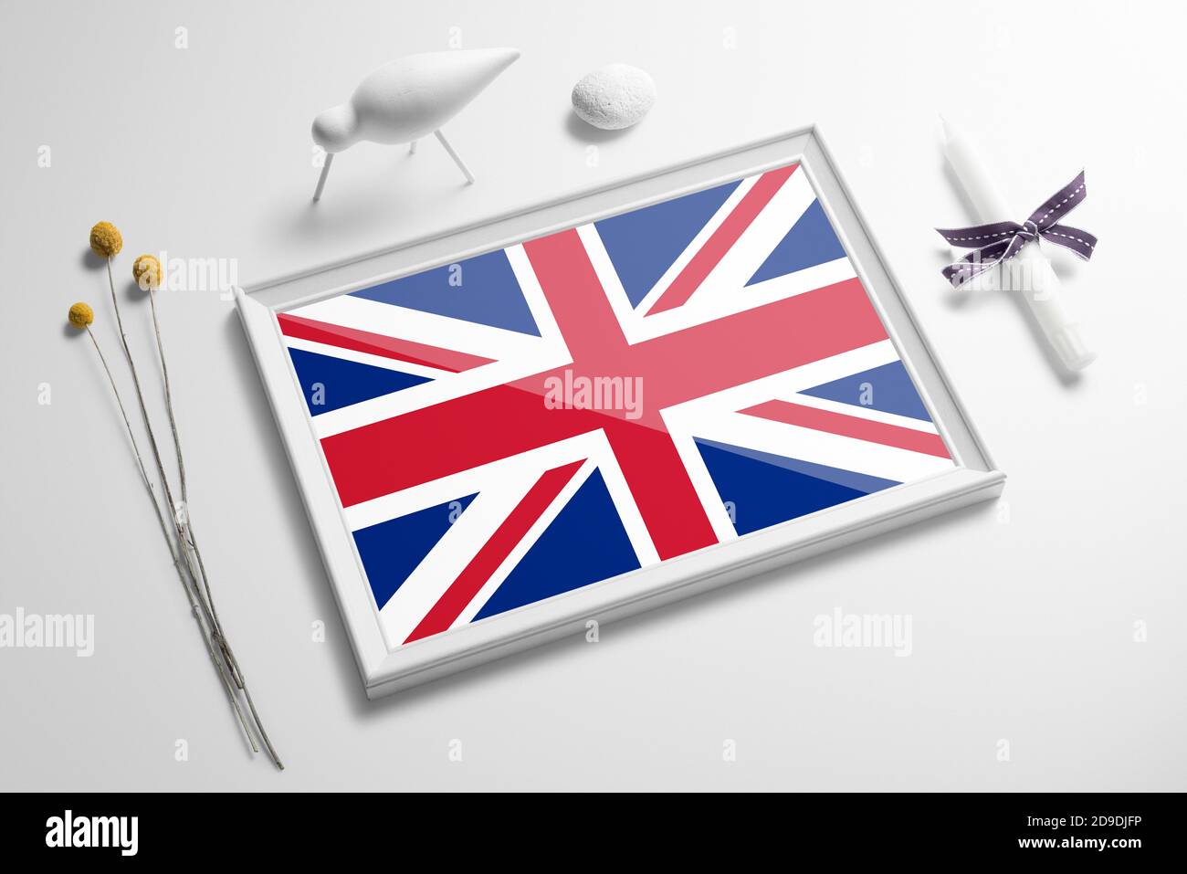 United Kingdom flag in wooden frame on table. White natural soft ...