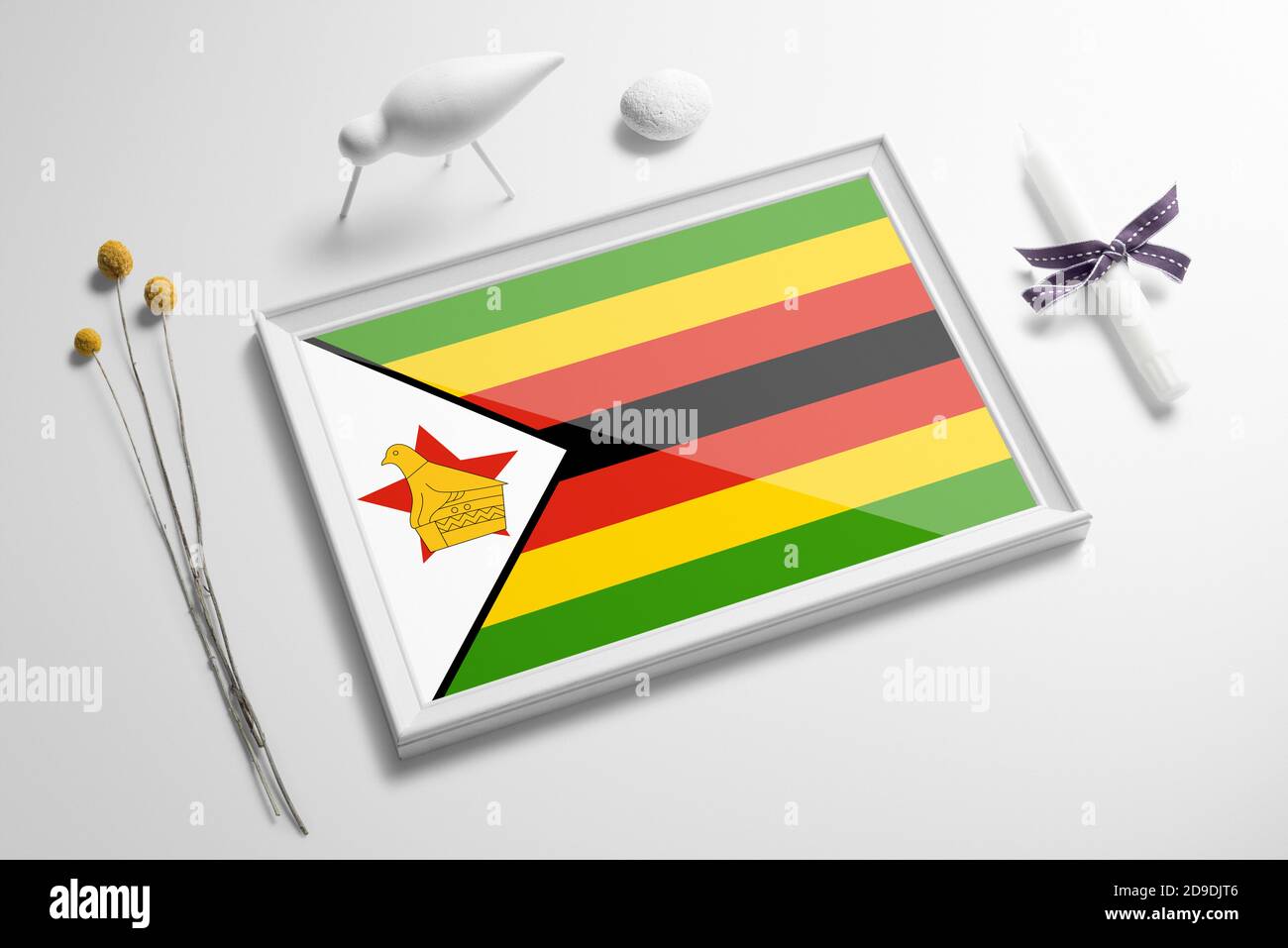 Zimbabwe flag in wooden frame on table. White natural soft concept ...