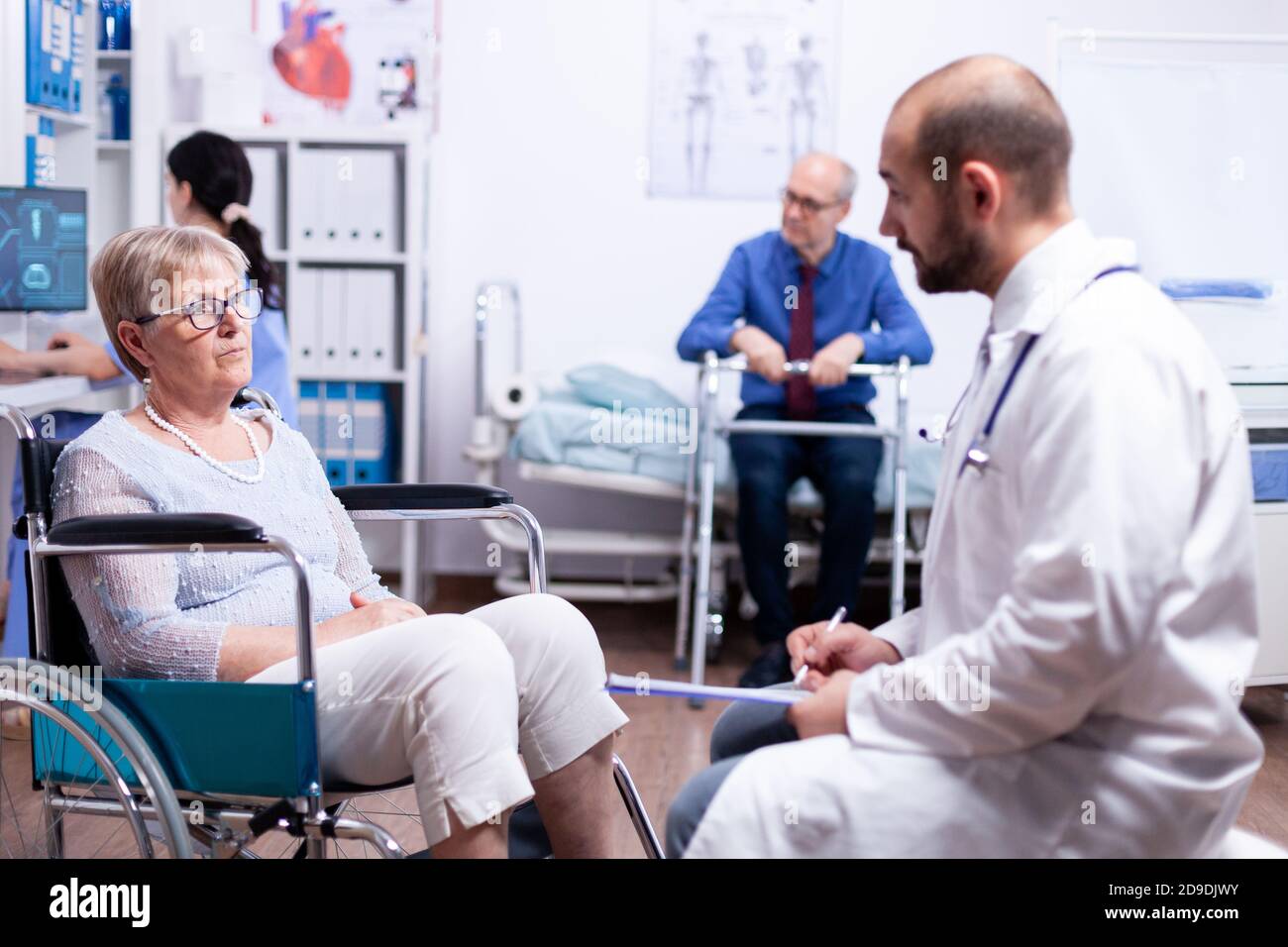 Doctor consultation in recovery clinic of handicapped senior woman in ...
