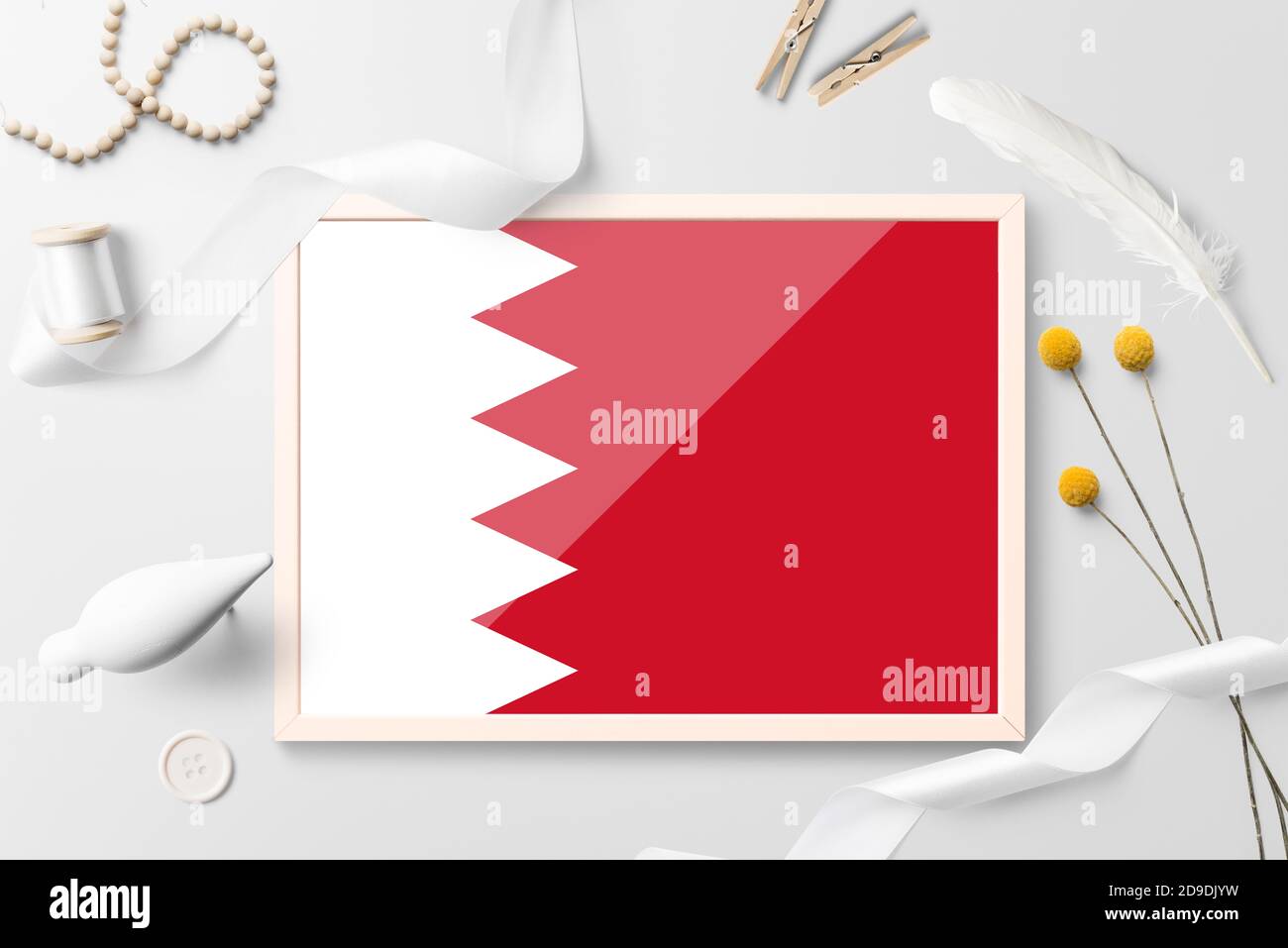 Bahrain flag in wooden frame on white creative background. White theme ...