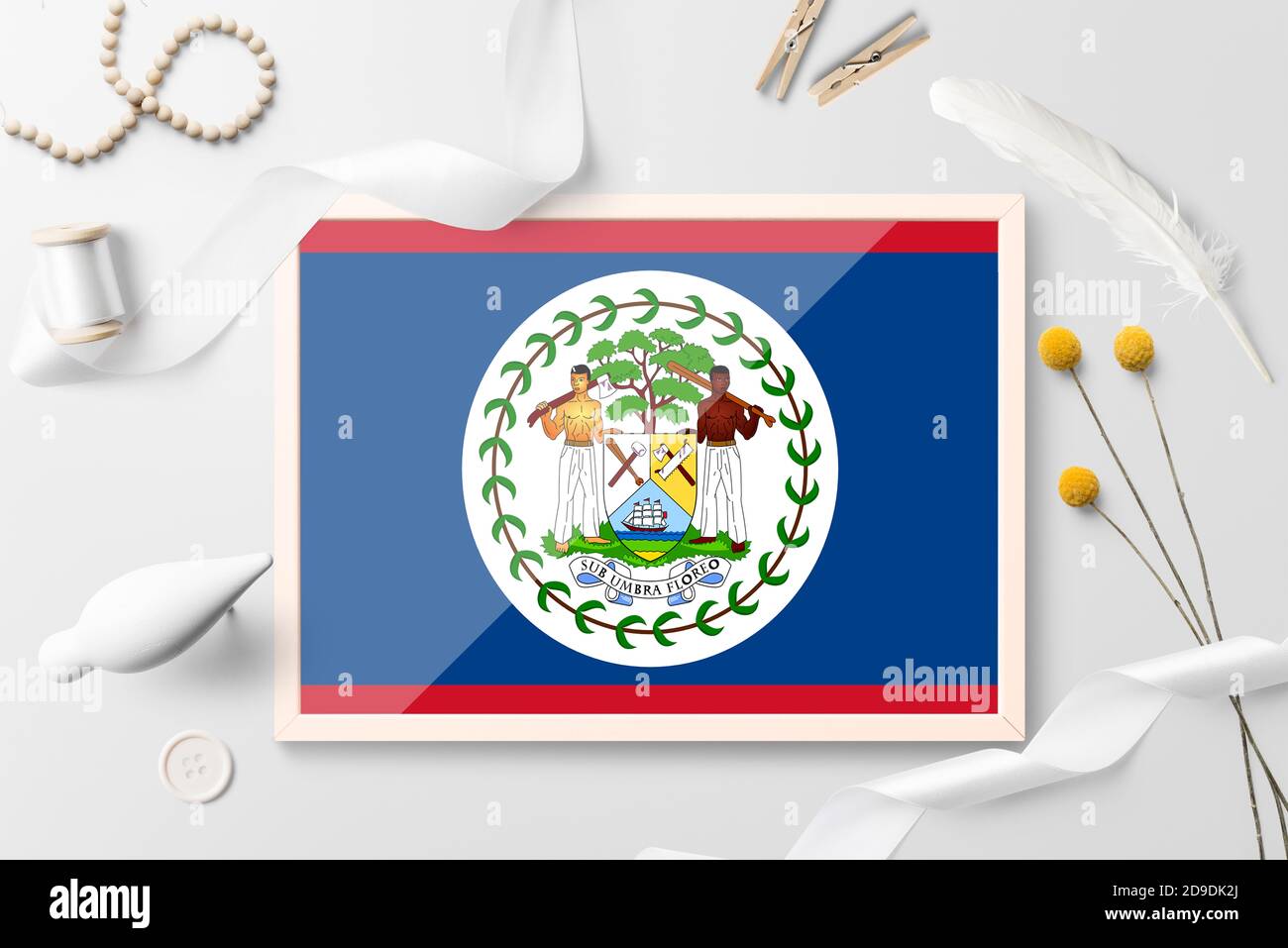 Belize flag in wooden frame on white creative background. White theme ...