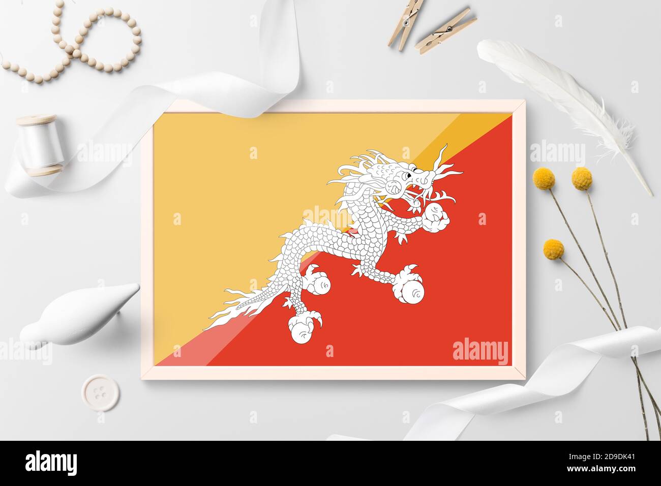 Bhutan flag in wooden frame on white creative background. White theme ...