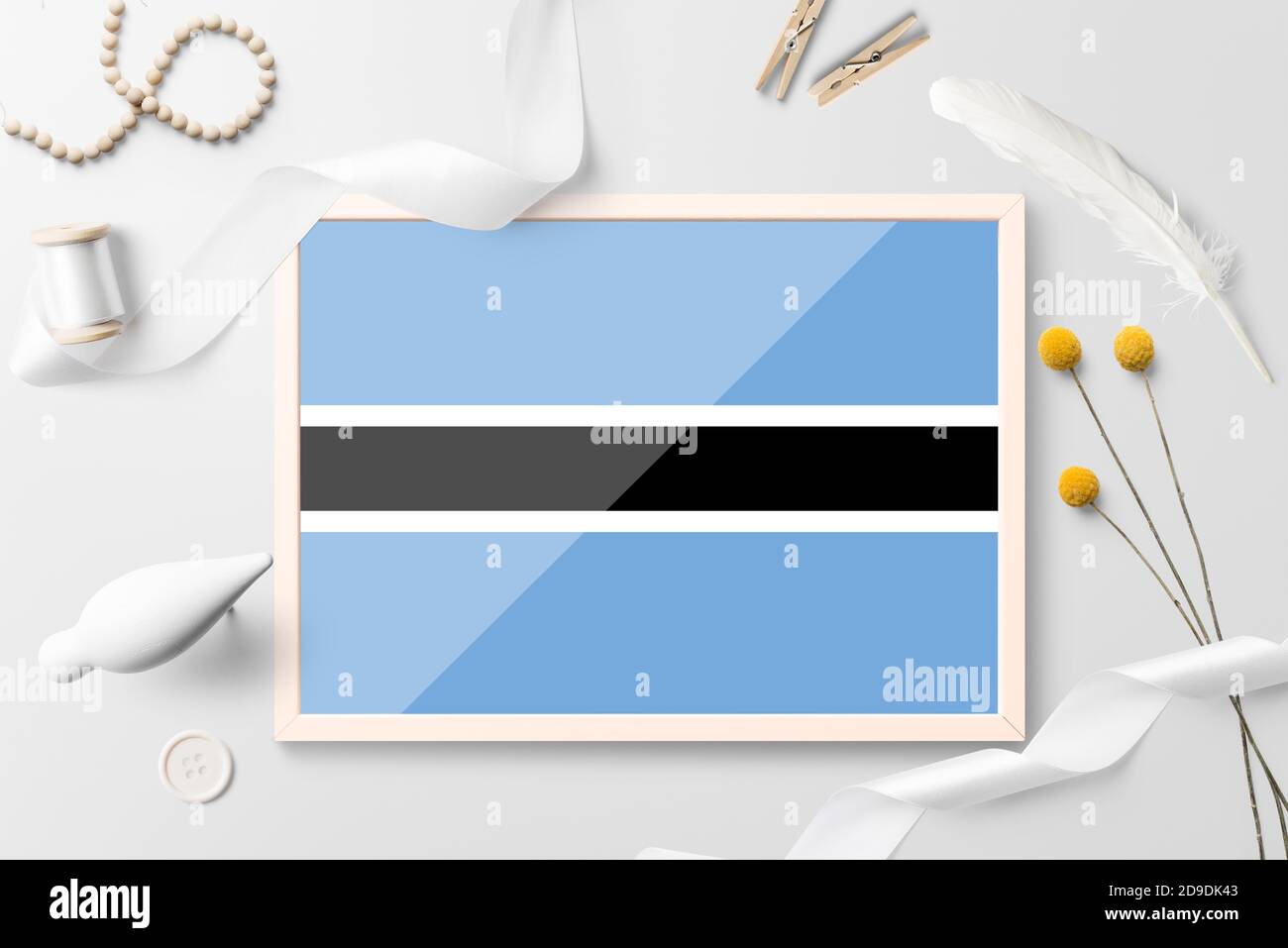 Botswana flag in wooden frame on white creative background. White theme ...