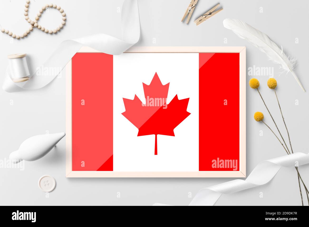 Canada flag in wooden frame on white creative background. White theme ...