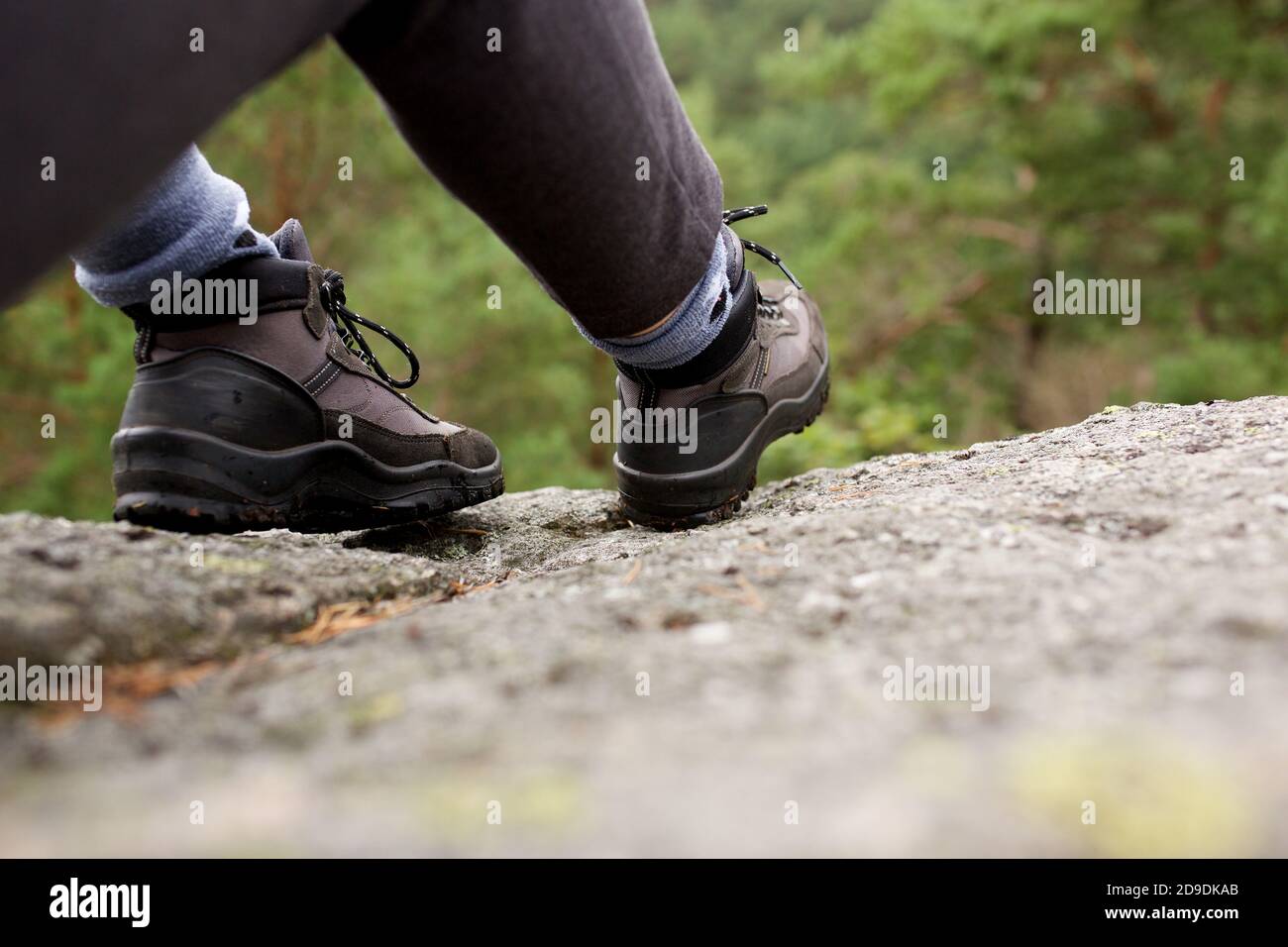 Portrait of legs with hiking boots on rock Stock Photo - Alamy