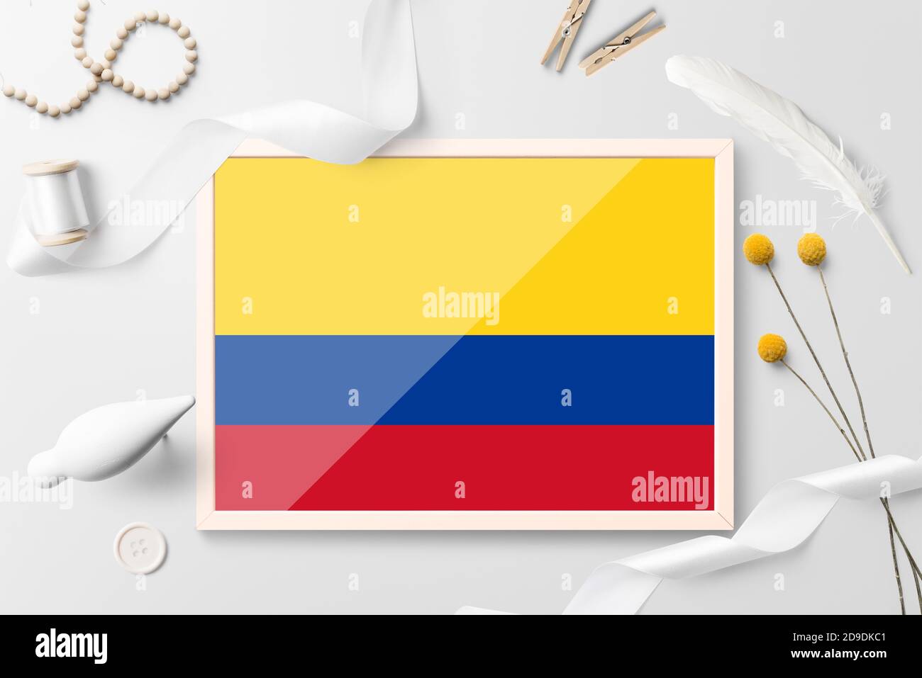 Colombia flag in wooden frame on white creative background. White theme ...