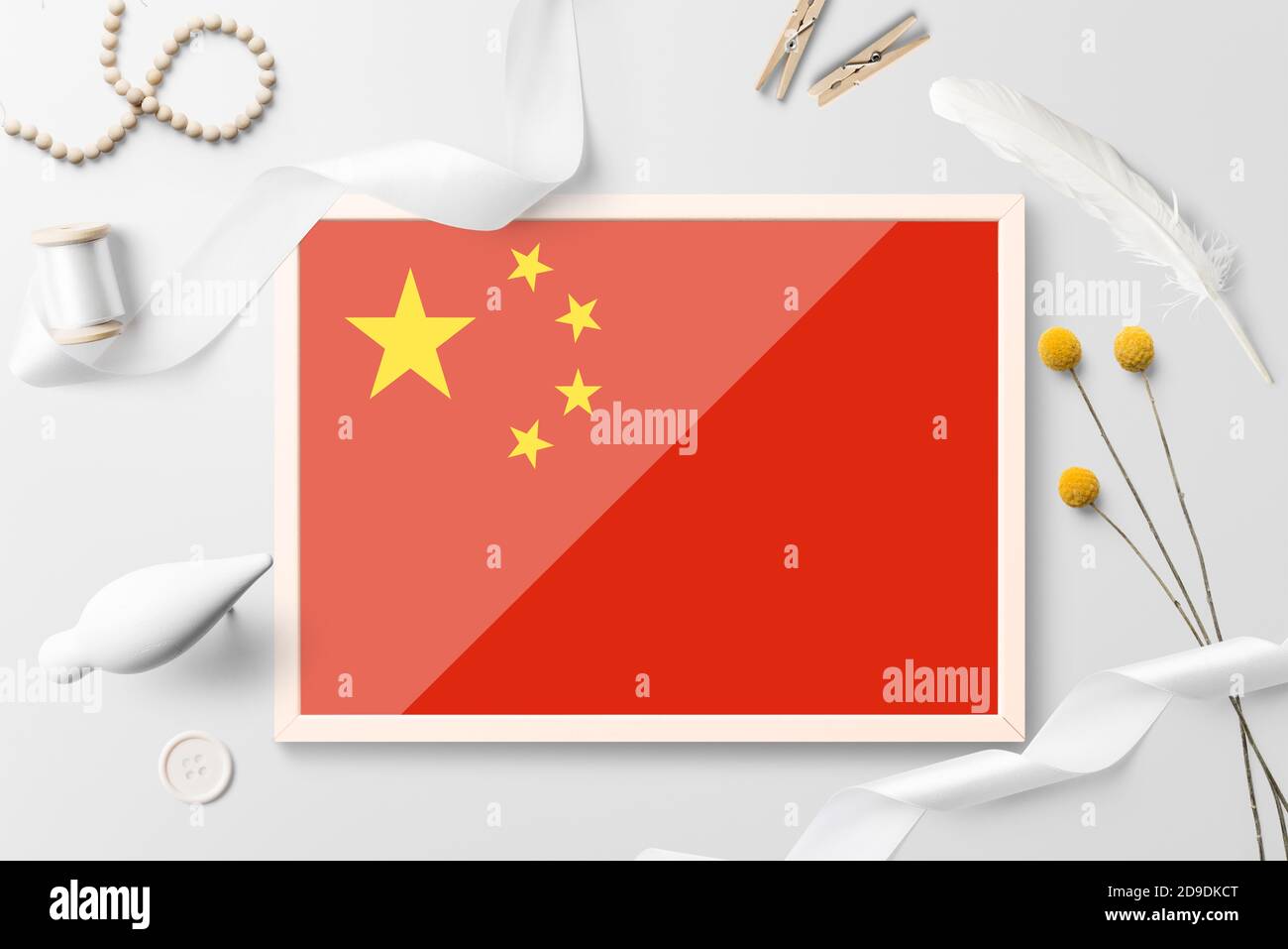 China flag in wooden frame on white creative background. White theme ...