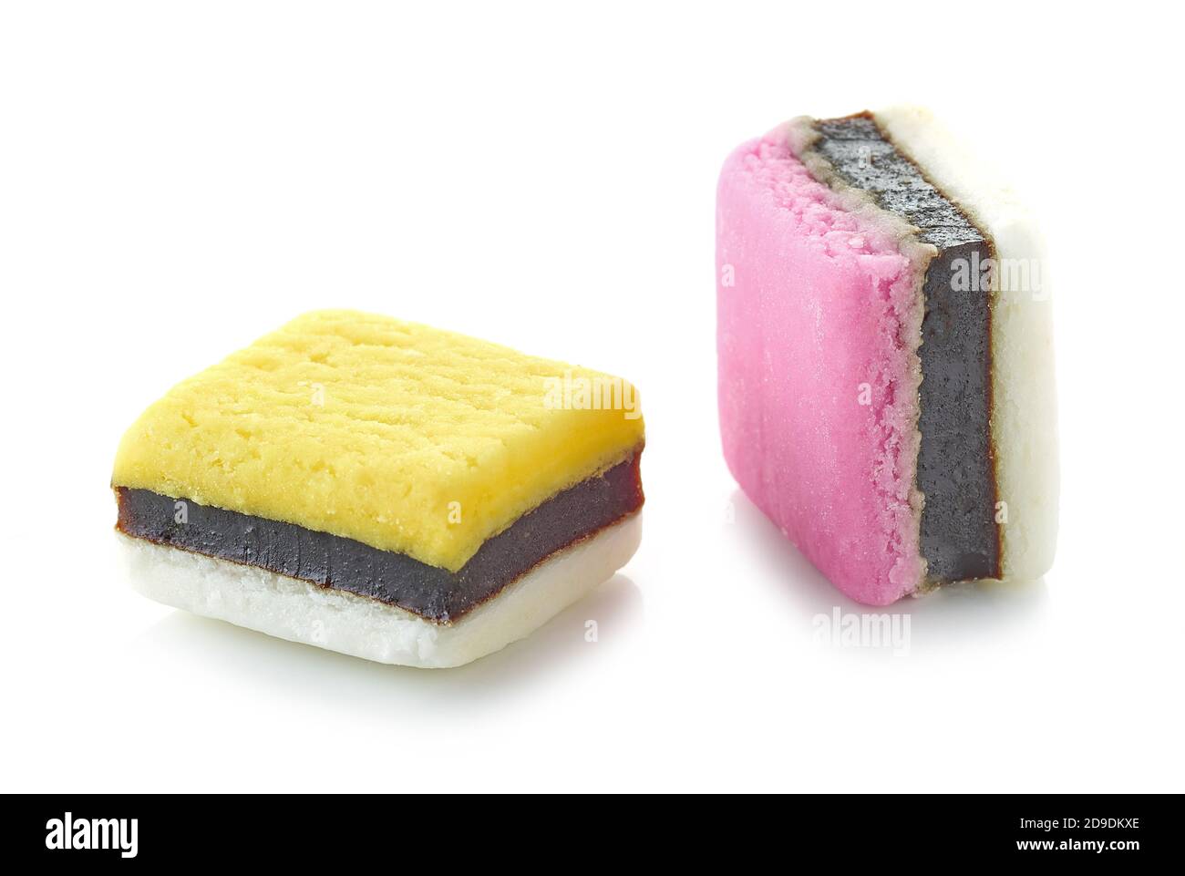 two pink and yellow candies with licorice isolated on white background ...