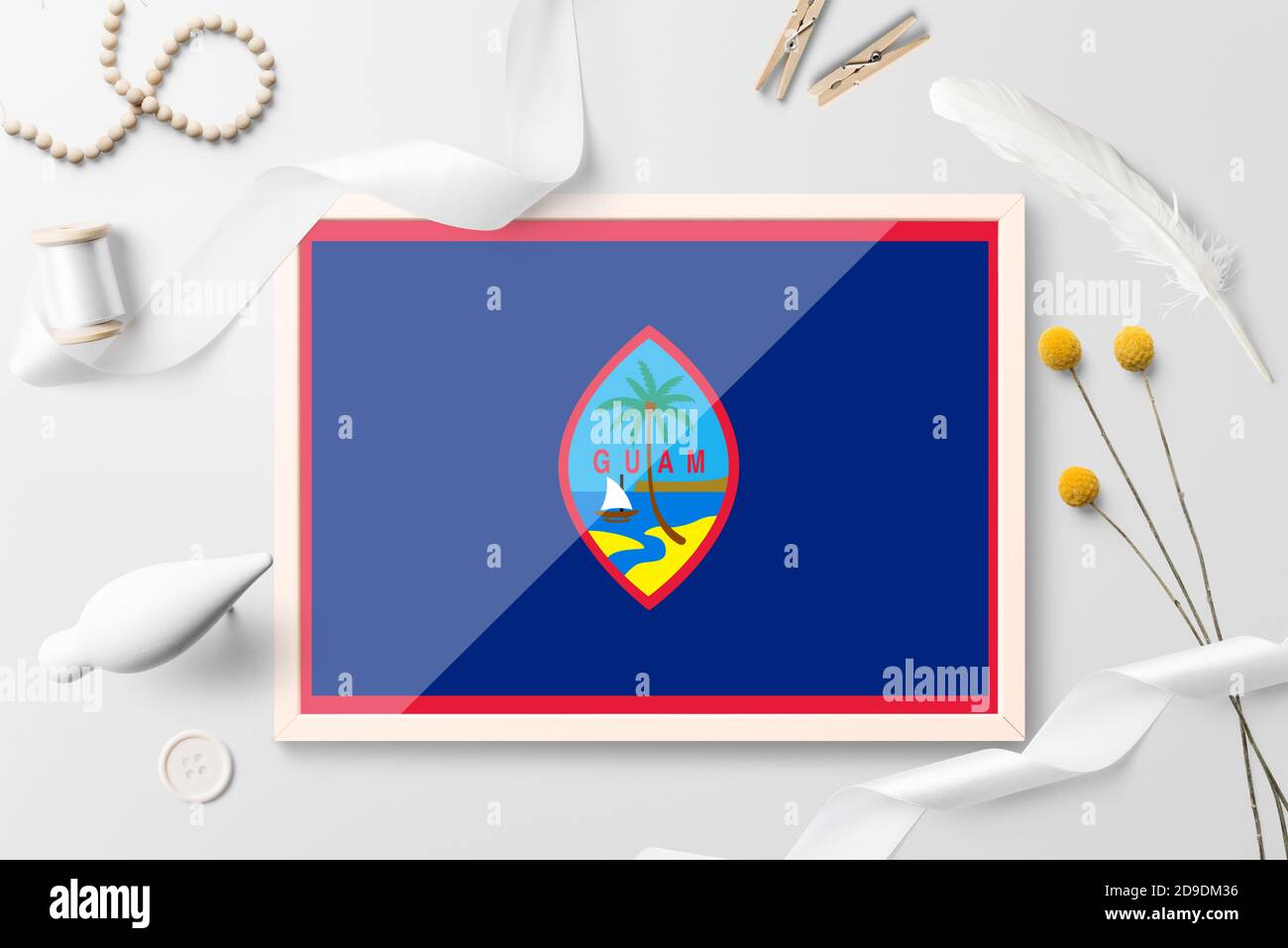 Guam flag in wooden frame on white creative background. White theme ...