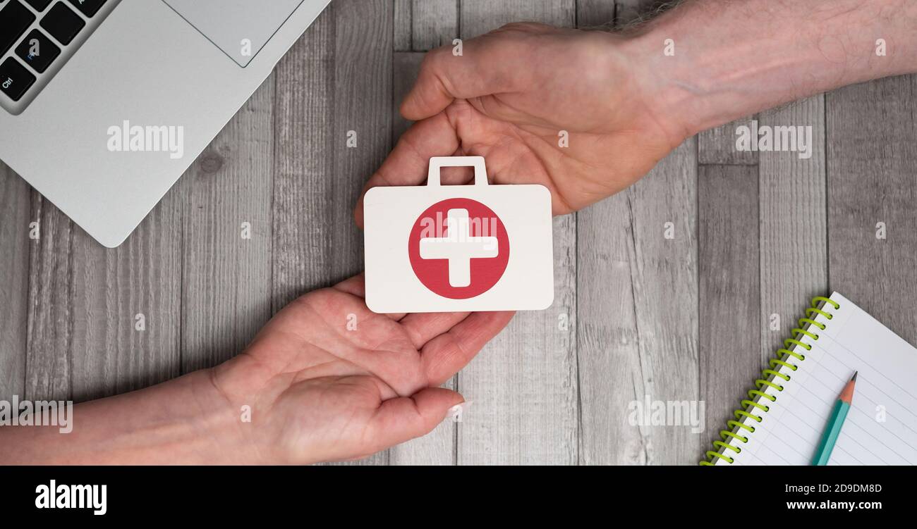 Hands holding a paper medical briefcase; Symbol of health insurance ...