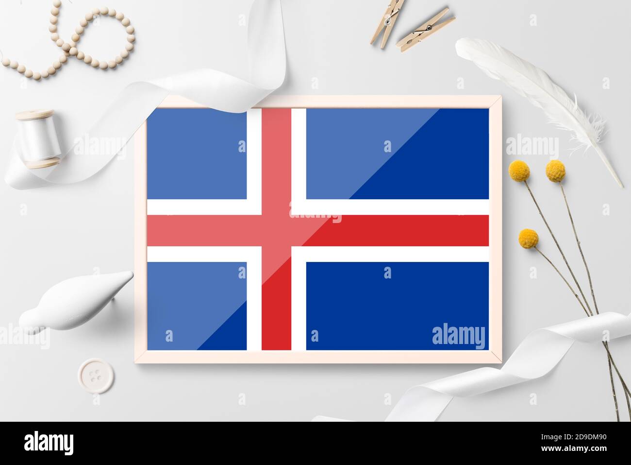 Iceland flag in wooden frame on white creative background. White theme ...