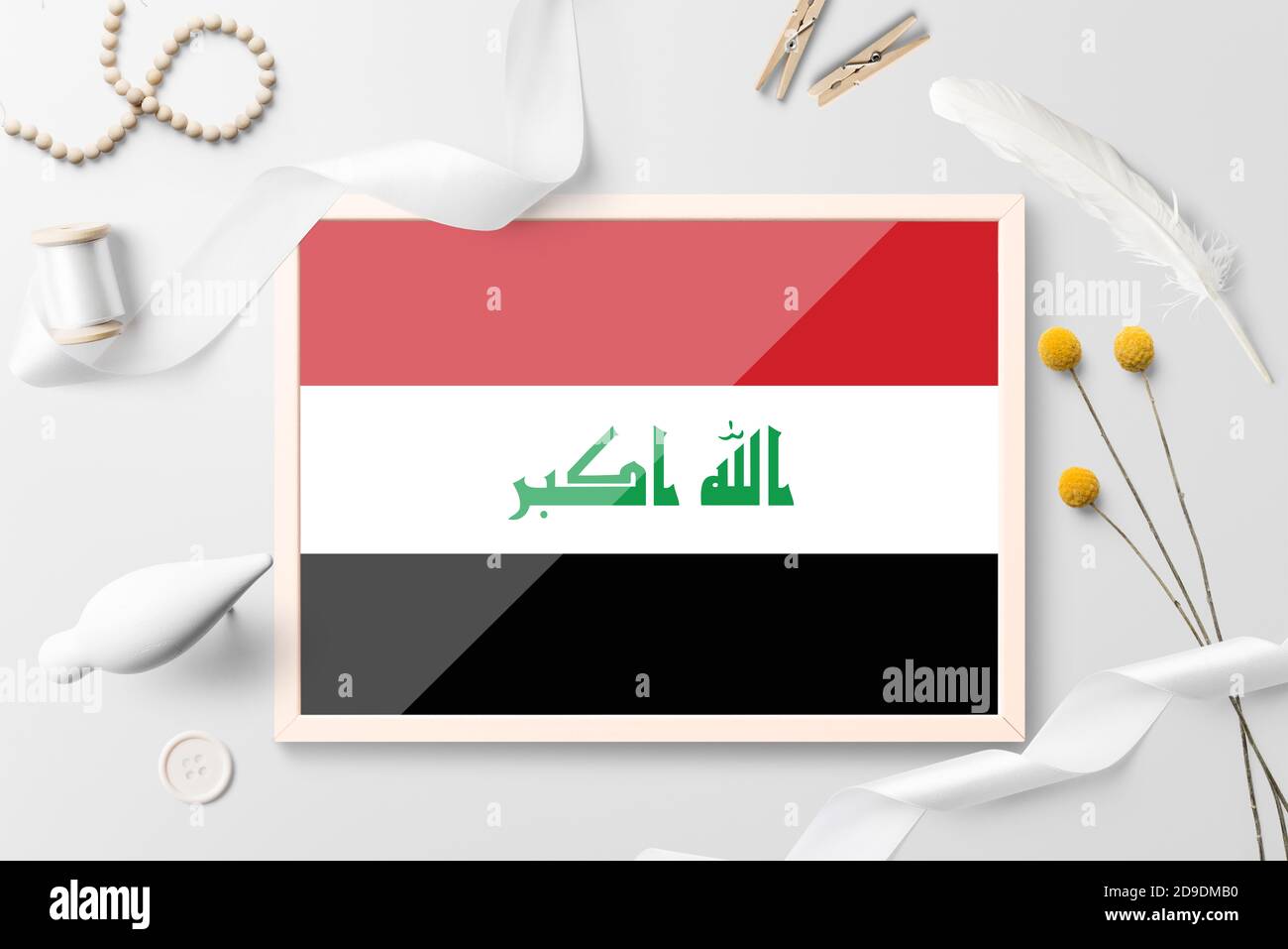 Iraq flag in wooden frame on white creative background. White theme ...